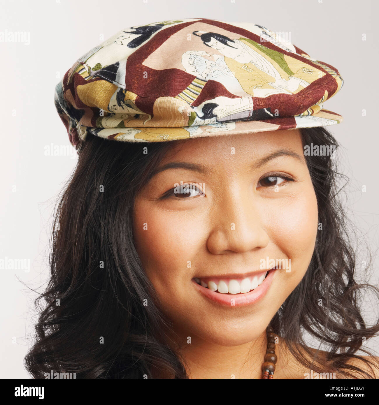 Portrait of a young woman wearing a cap and smiling Stock Photo - Alamy