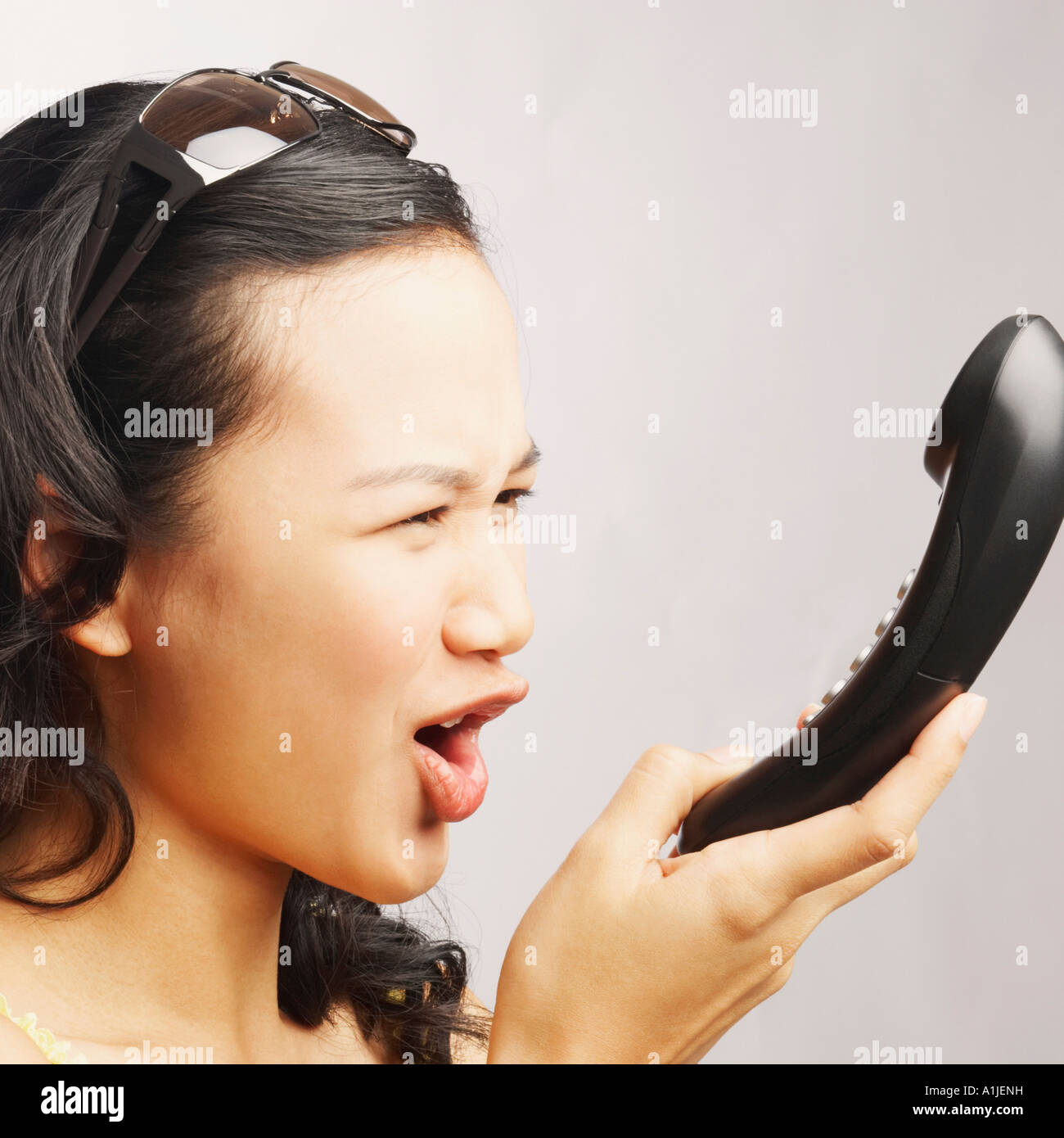 Side profile of a young woman shouting on the phone Stock Photo - Alamy
