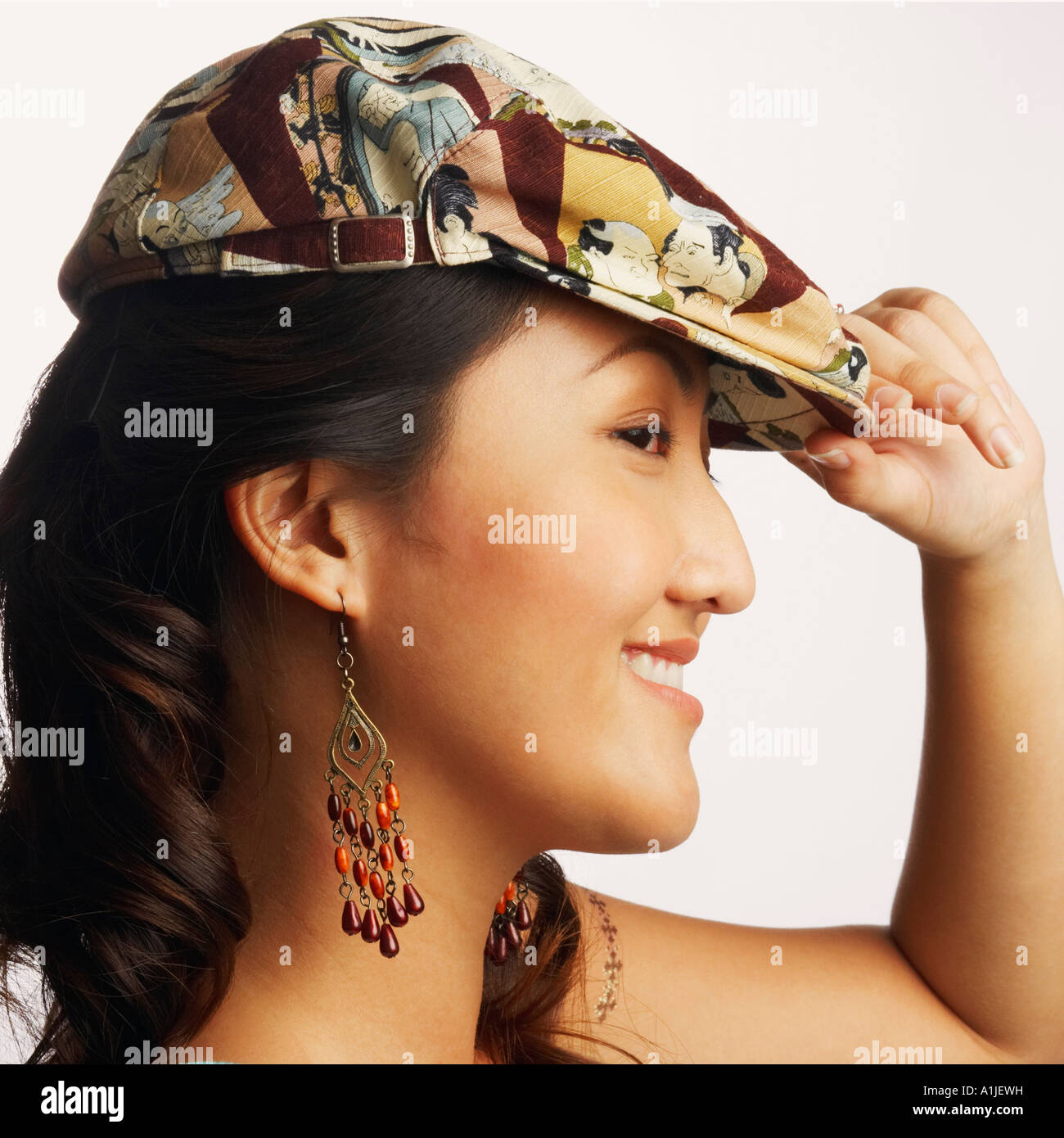 Side profile of a young woman wearing a cap and smiling Stock Photo - Alamy