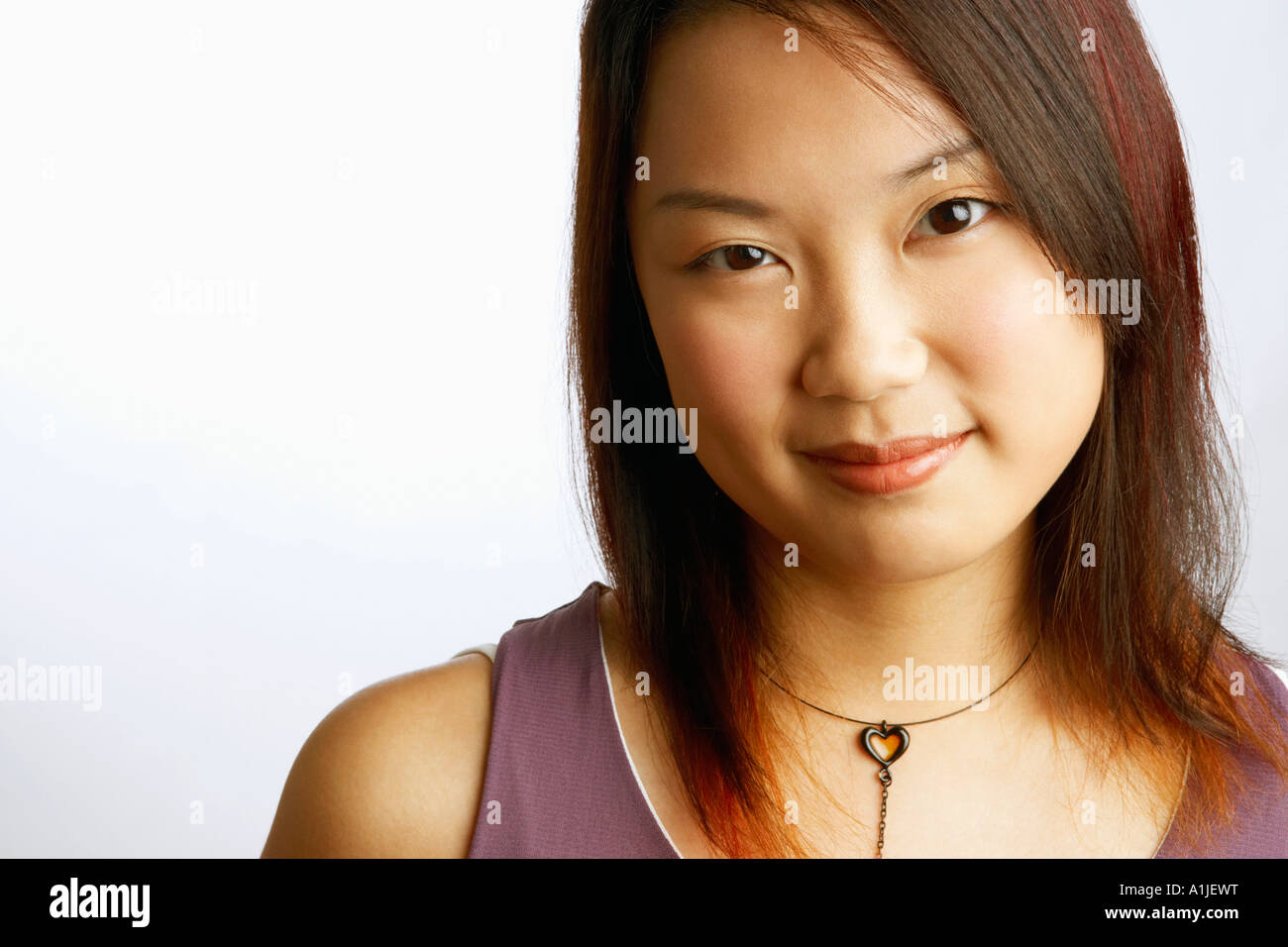Portrait of a young woman smirking Stock Photo - Alamy