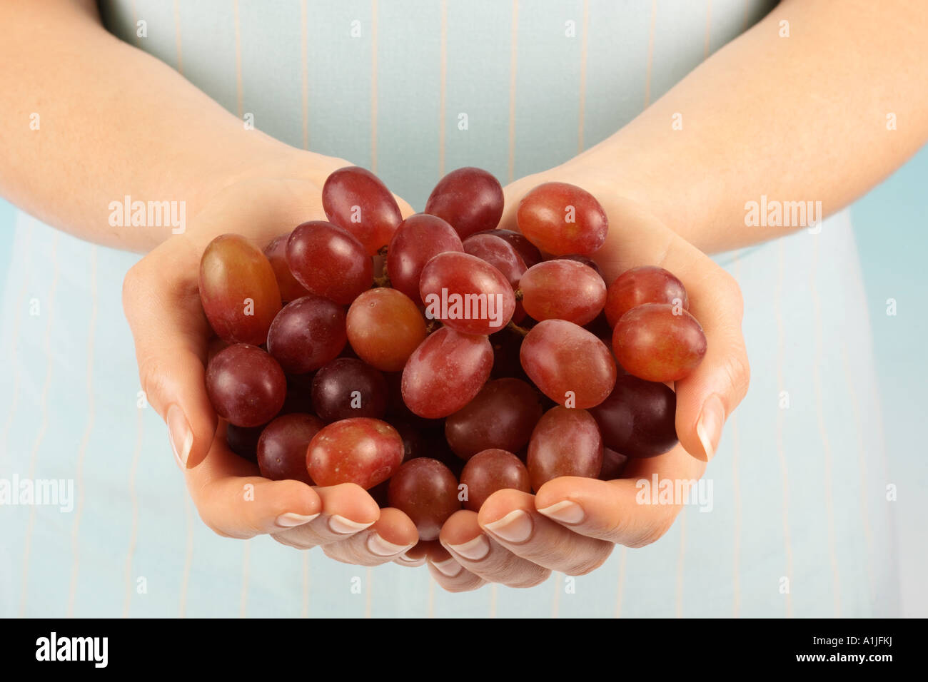 Woman holding grapes hi-res stock photography and images - Alamy