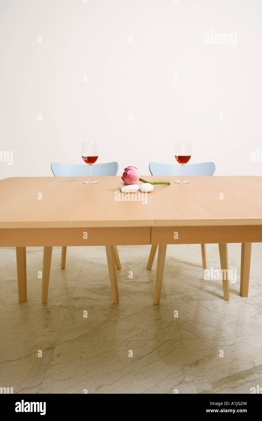 Two glasses of red wine with a lotus on the table Stock Photo - Alamy