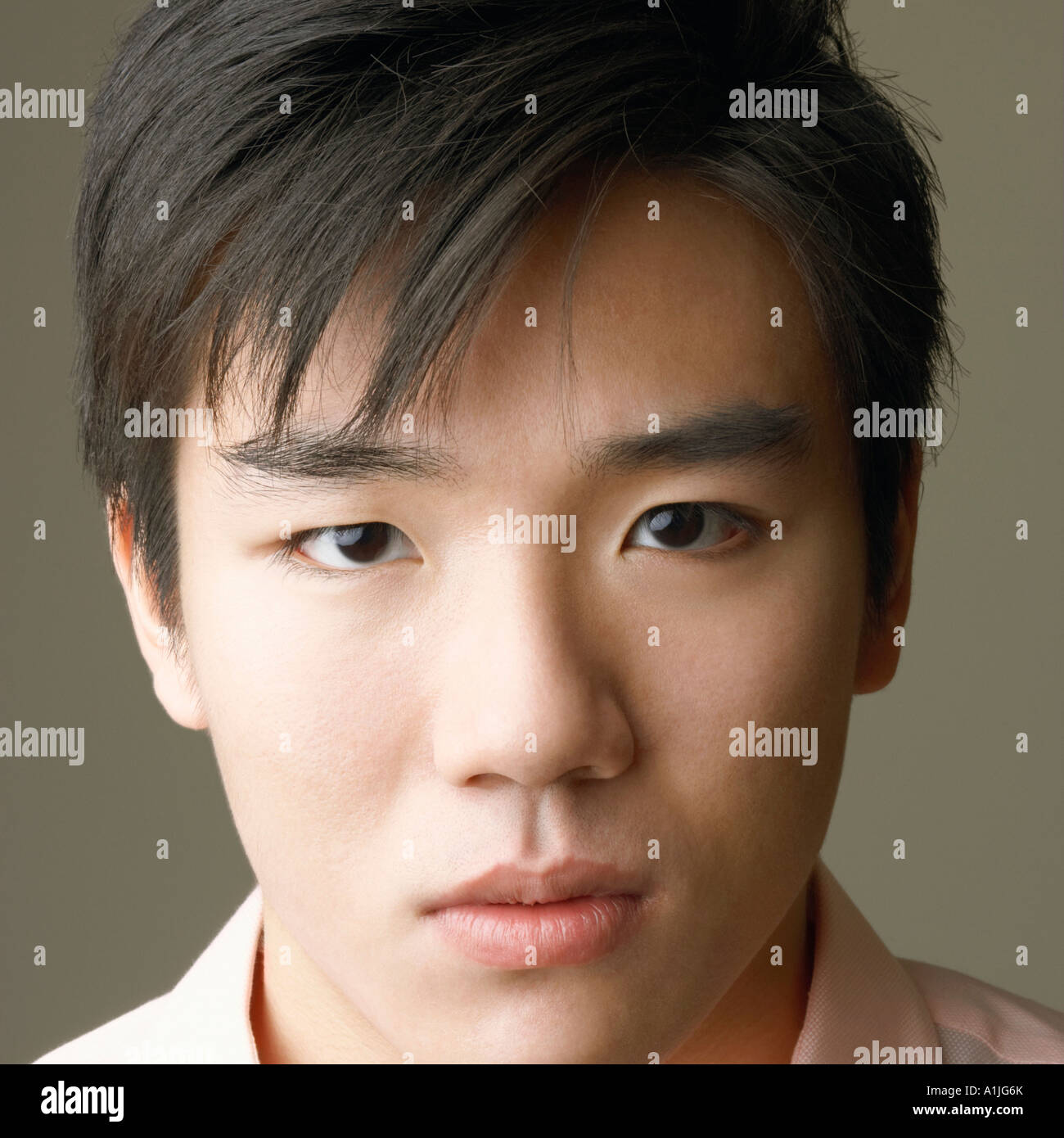 Portrait of a young man looking serious Stock Photo - Alamy