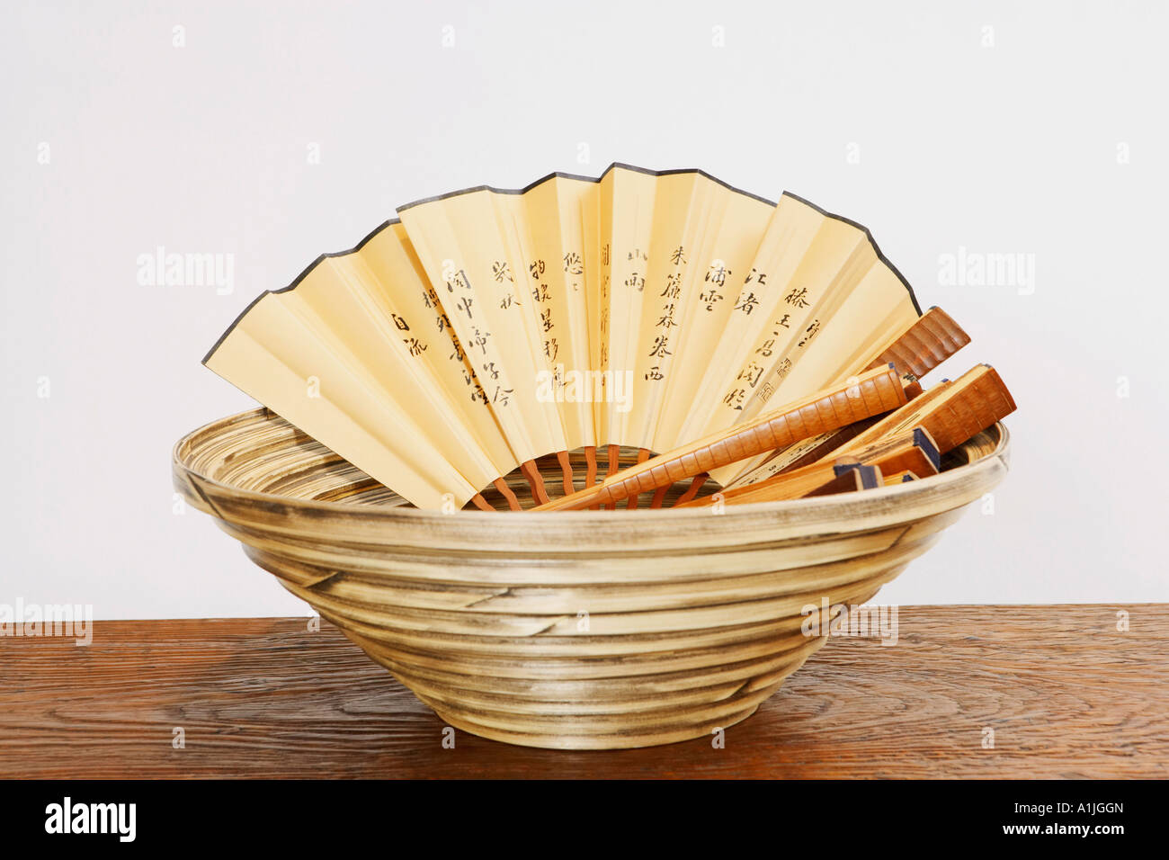Close-up of folding fans in a basket Stock Photo - Alamy