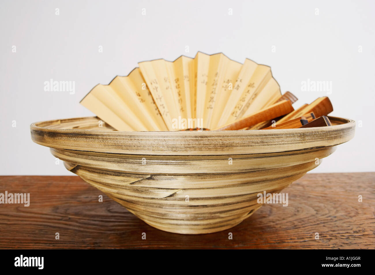 Close-up of folding fans in a basket Stock Photo - Alamy