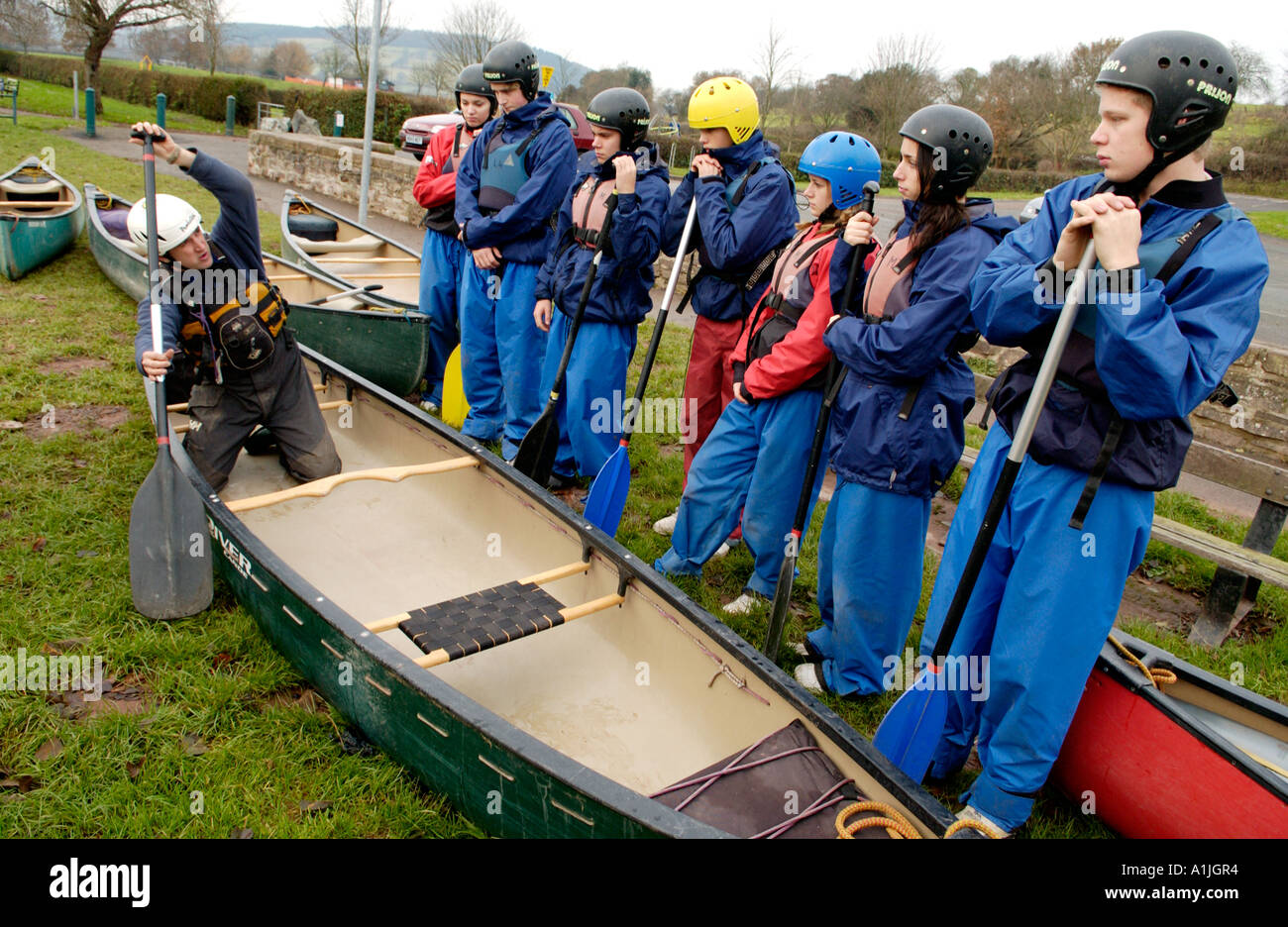Instructor demonstrating open canoe technique to group of students on ...