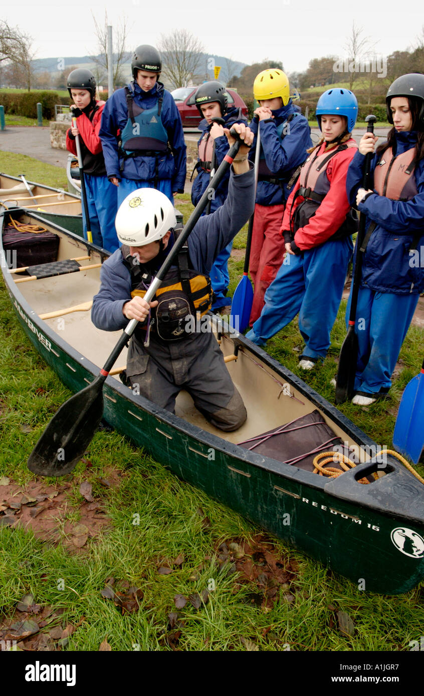 Instructor demonstrating open canoe technique to group of students on ...