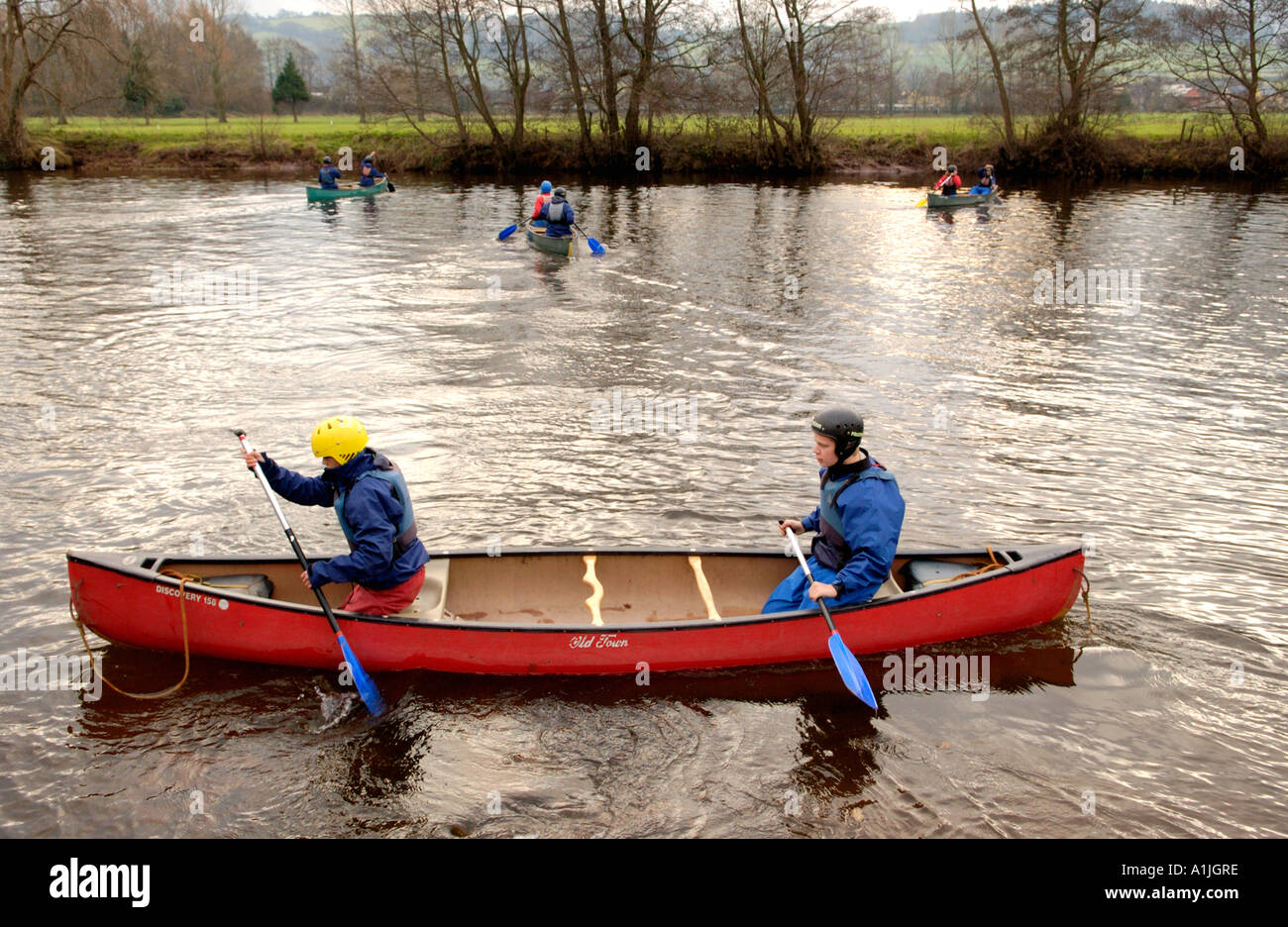 Students on an adventure trip on the River Usk in open canoes at Brecon ...
