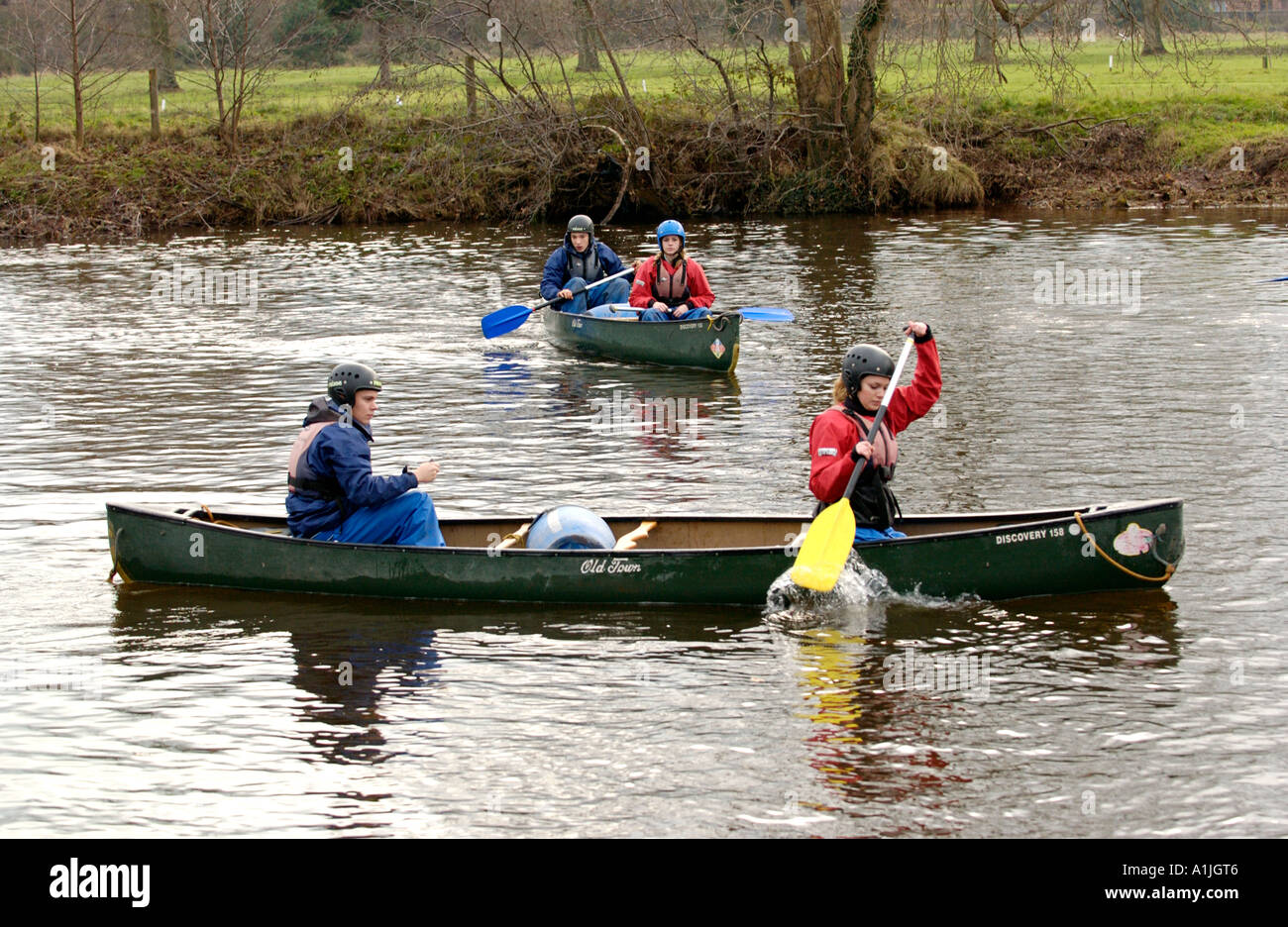 Students on an adventure trip on the River Usk in open canoes at Brecon ...