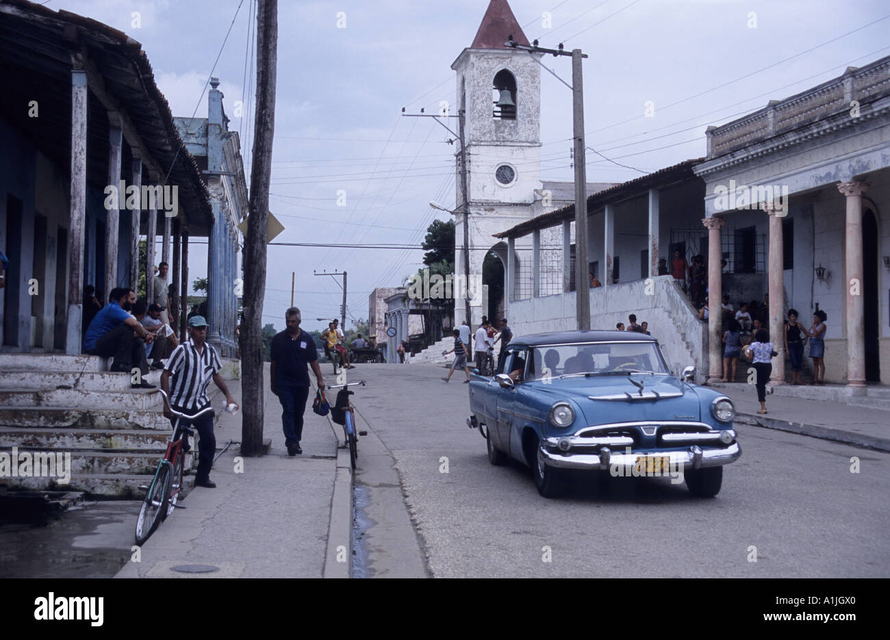 Streetscene with passing American oldtimer and church in street of ...