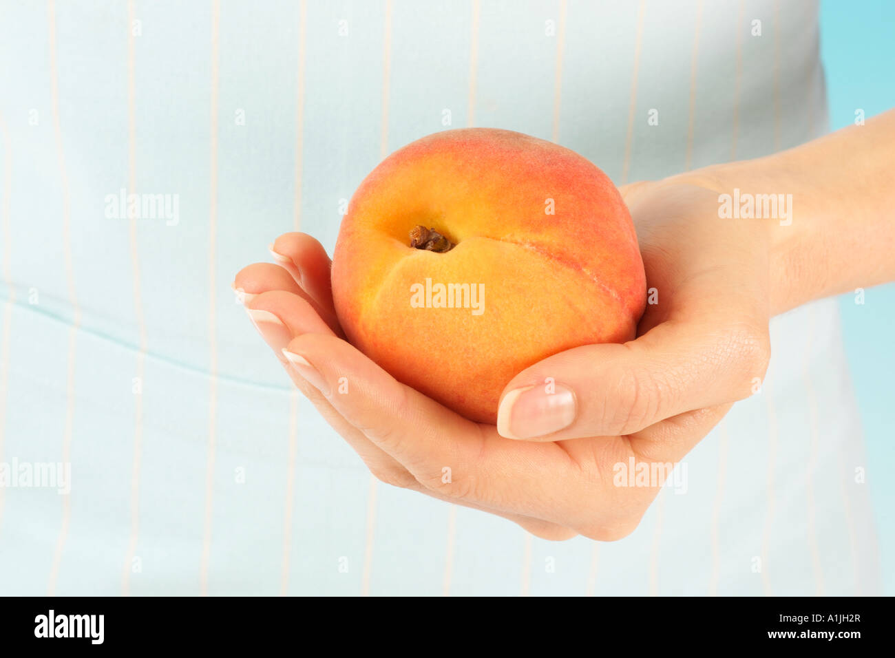 WOMAN HOLDING PEACH Stock Photo - Alamy