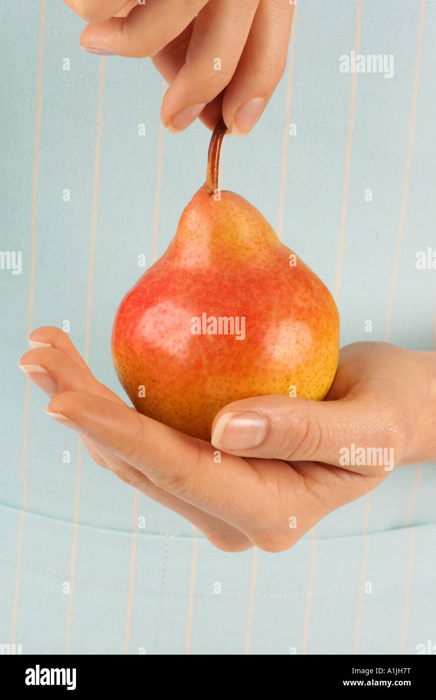 WOMAN HOLDING PEAR Stock Photo - Alamy