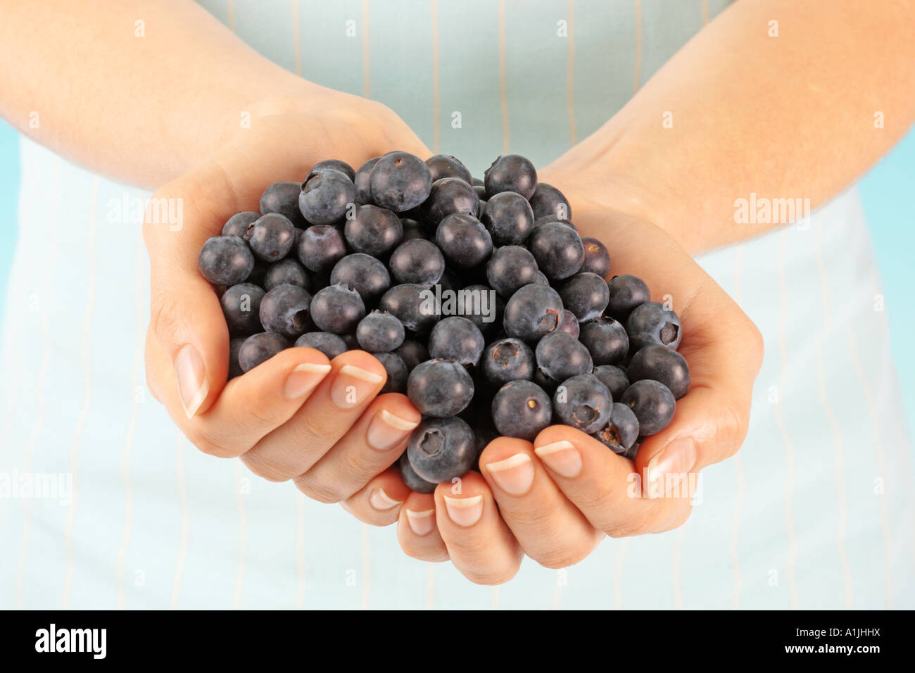 WOMAN WITH HANDFUL OF FRESH BLUEBERRIES Stock Photo - Alamy