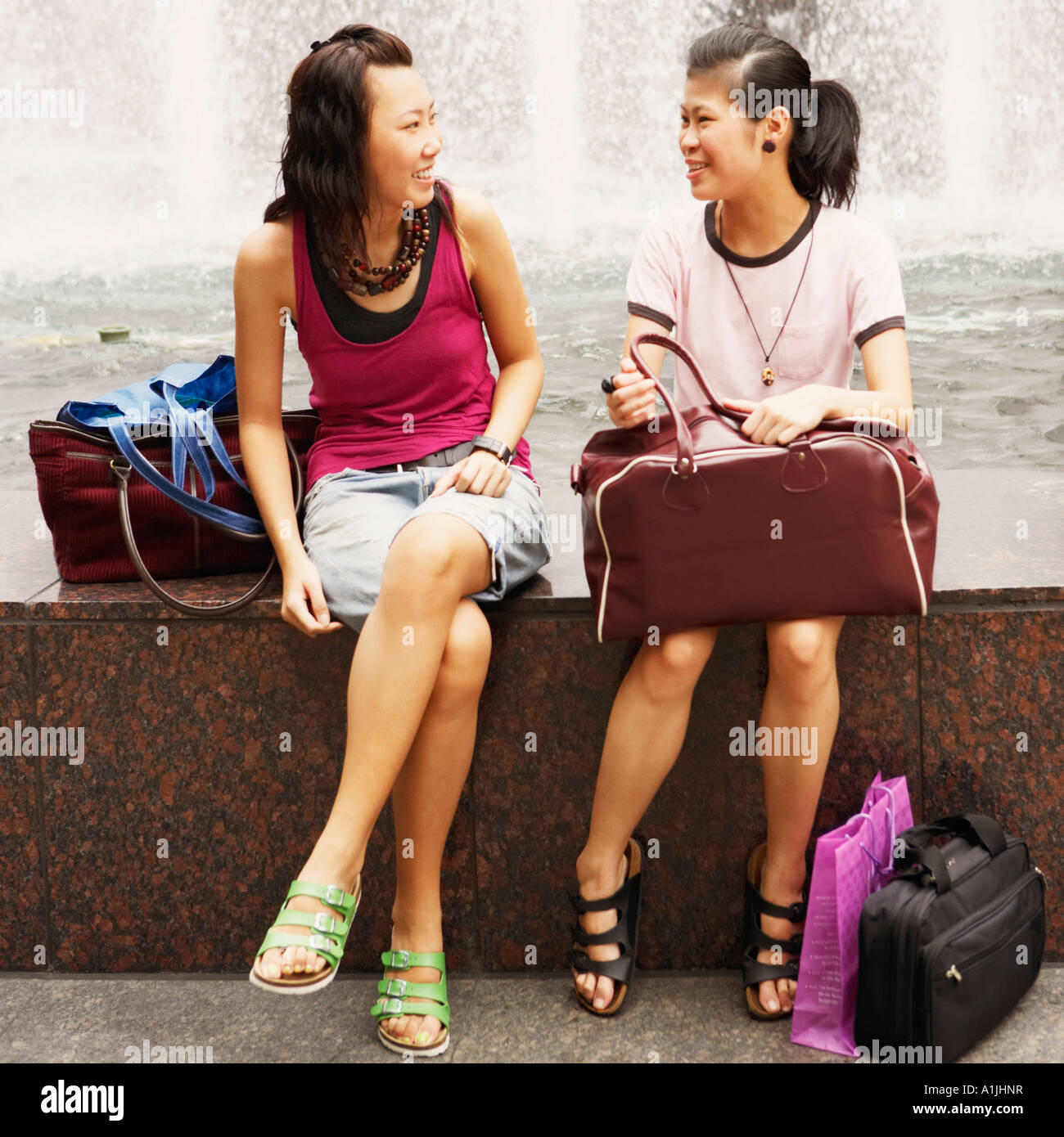 Young woman sitting near fountain hi-res stock photography and images ...