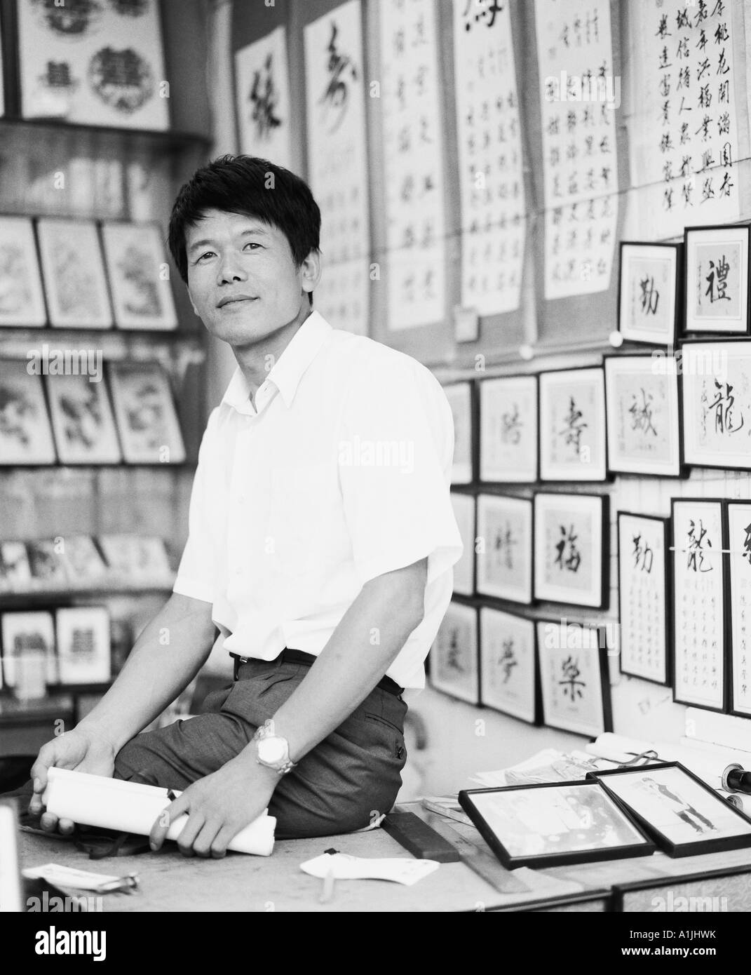 Sitting mid adult black Black and White Stock Photos & Images - Alamy