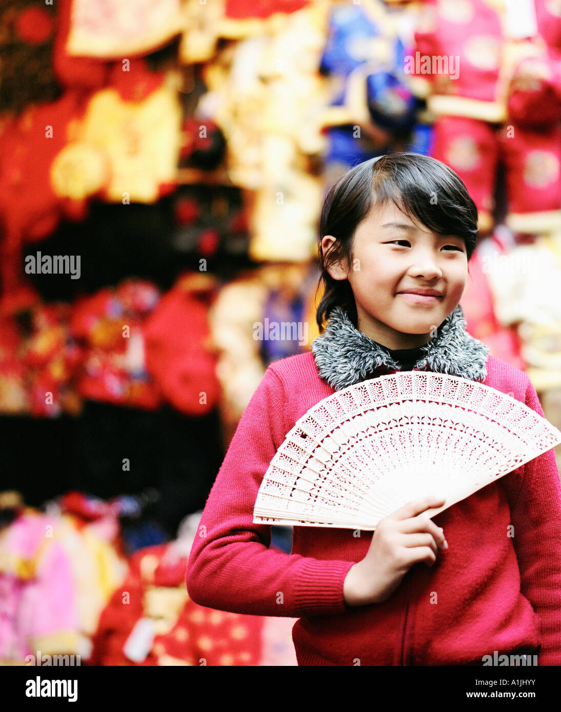 Girl holding a fan Stock Photo - Alamy