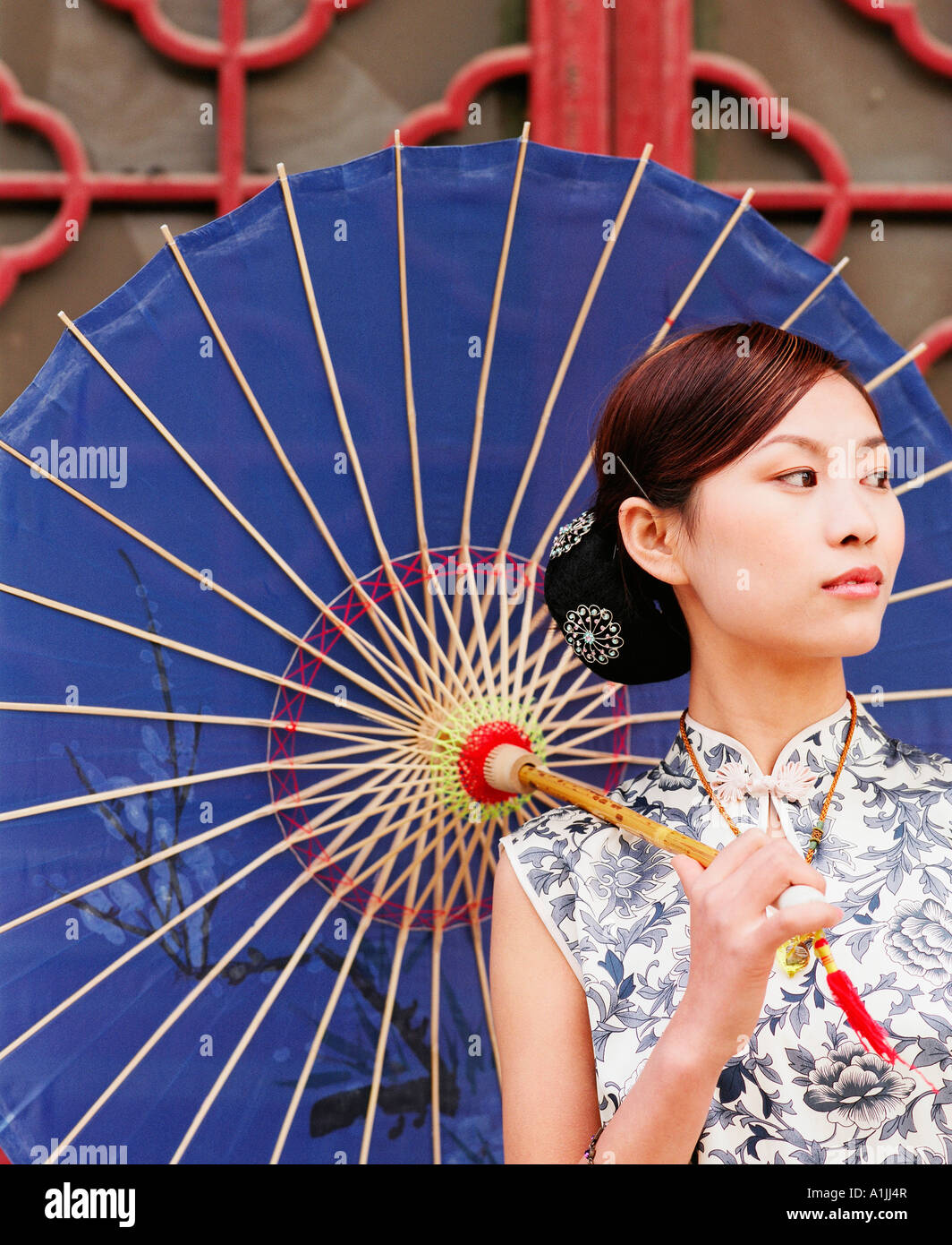 Close-up of a young woman holding a parasol and looking sideways Stock ...