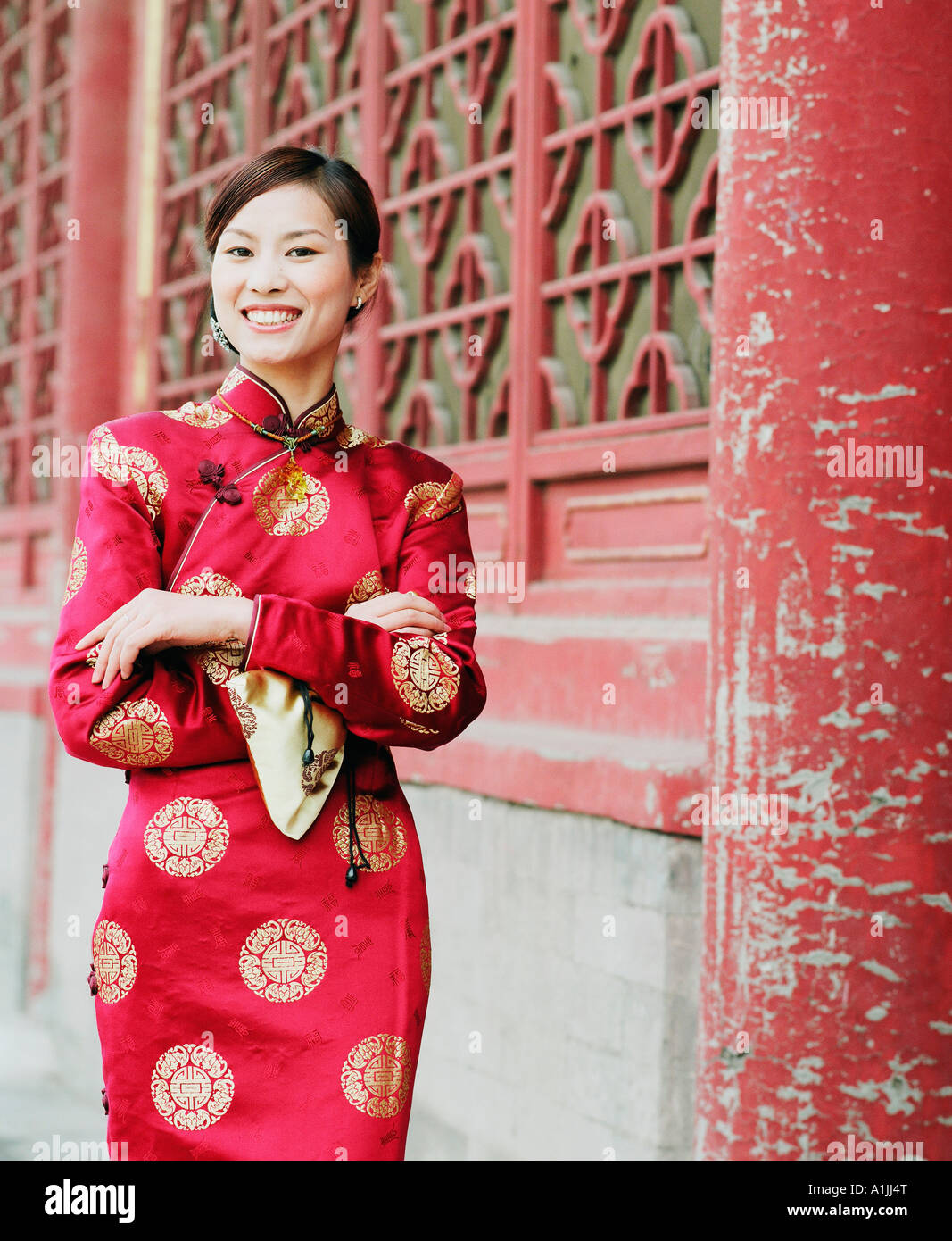 Portrait of a young woman standing in the traditional clothing and ...