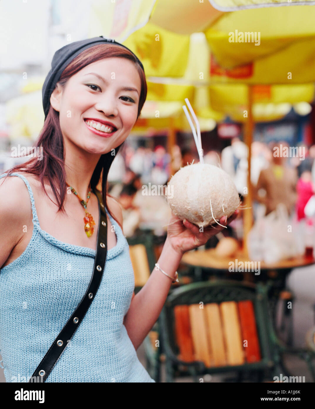 Woman drink coconut looking at camera hi-res stock photography and ...