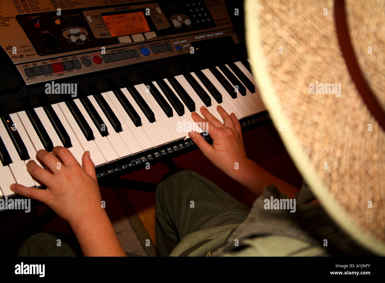a young boy is playing on his Keyboard Stock Photo - Alamy