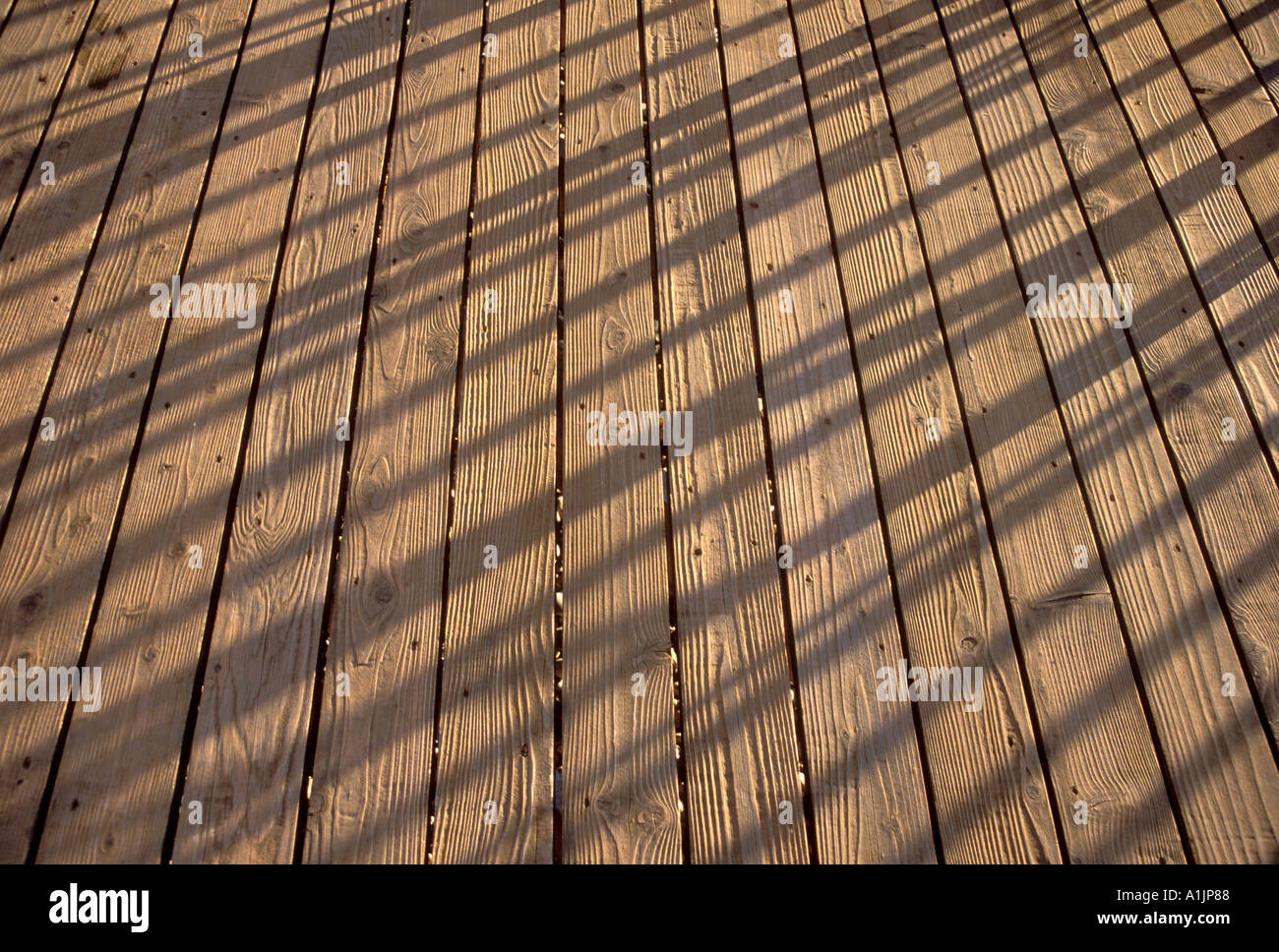 Wooden decking with shadows Stock Photo - Alamy