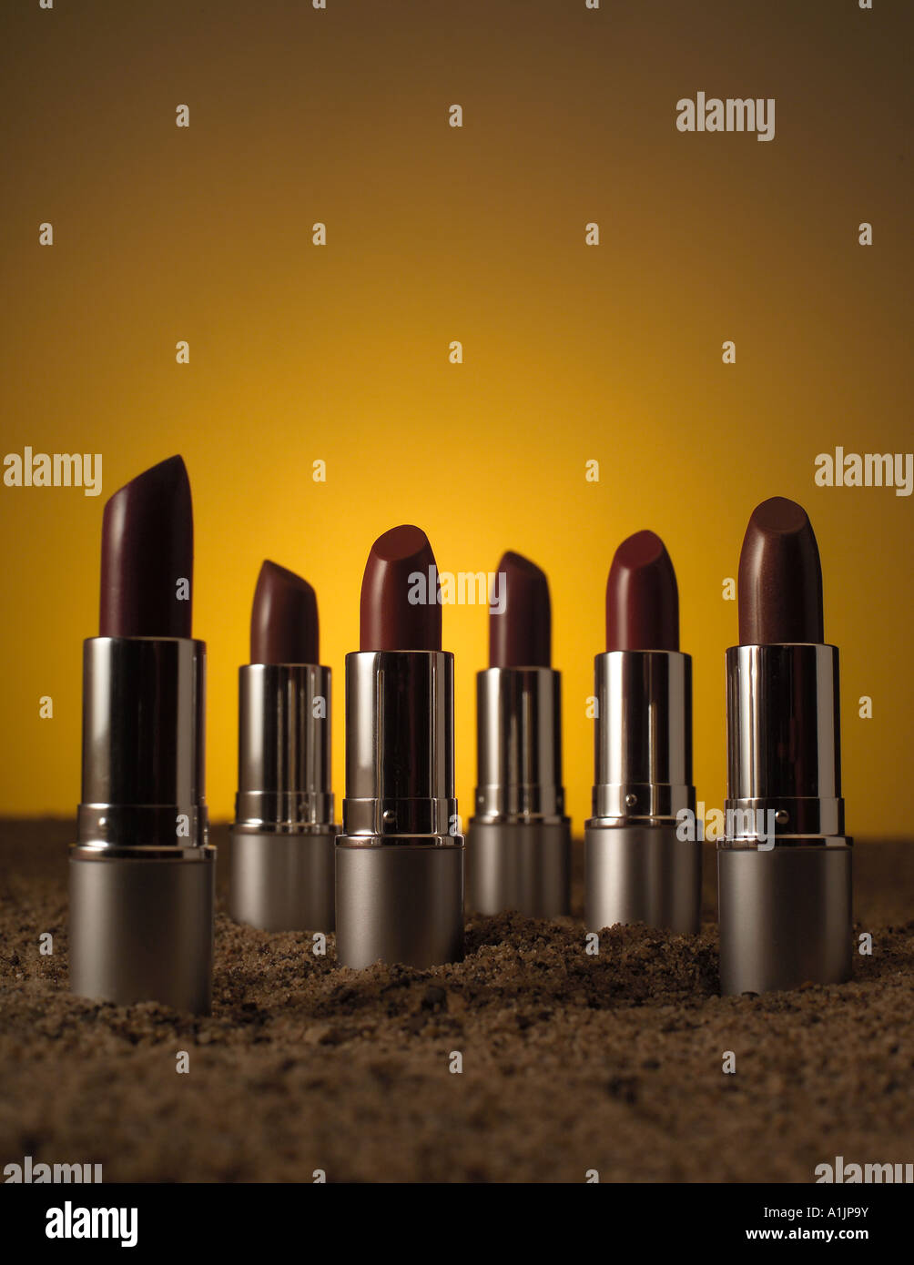 Lipstick in sand with sunset background Stock Photo - Alamy