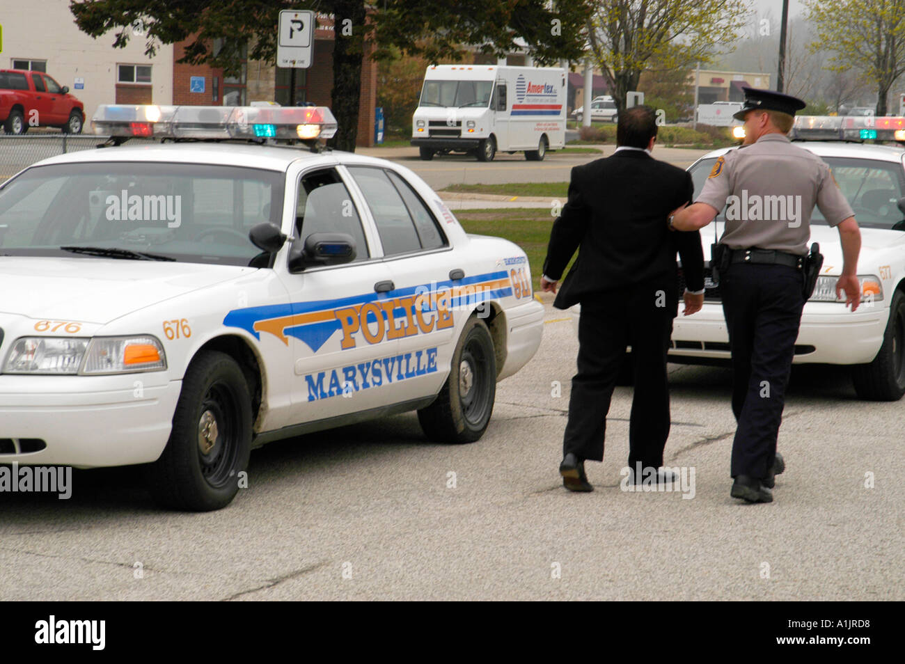Prom Drunk Driving Demo Police officer escorts drunk driver to police ...