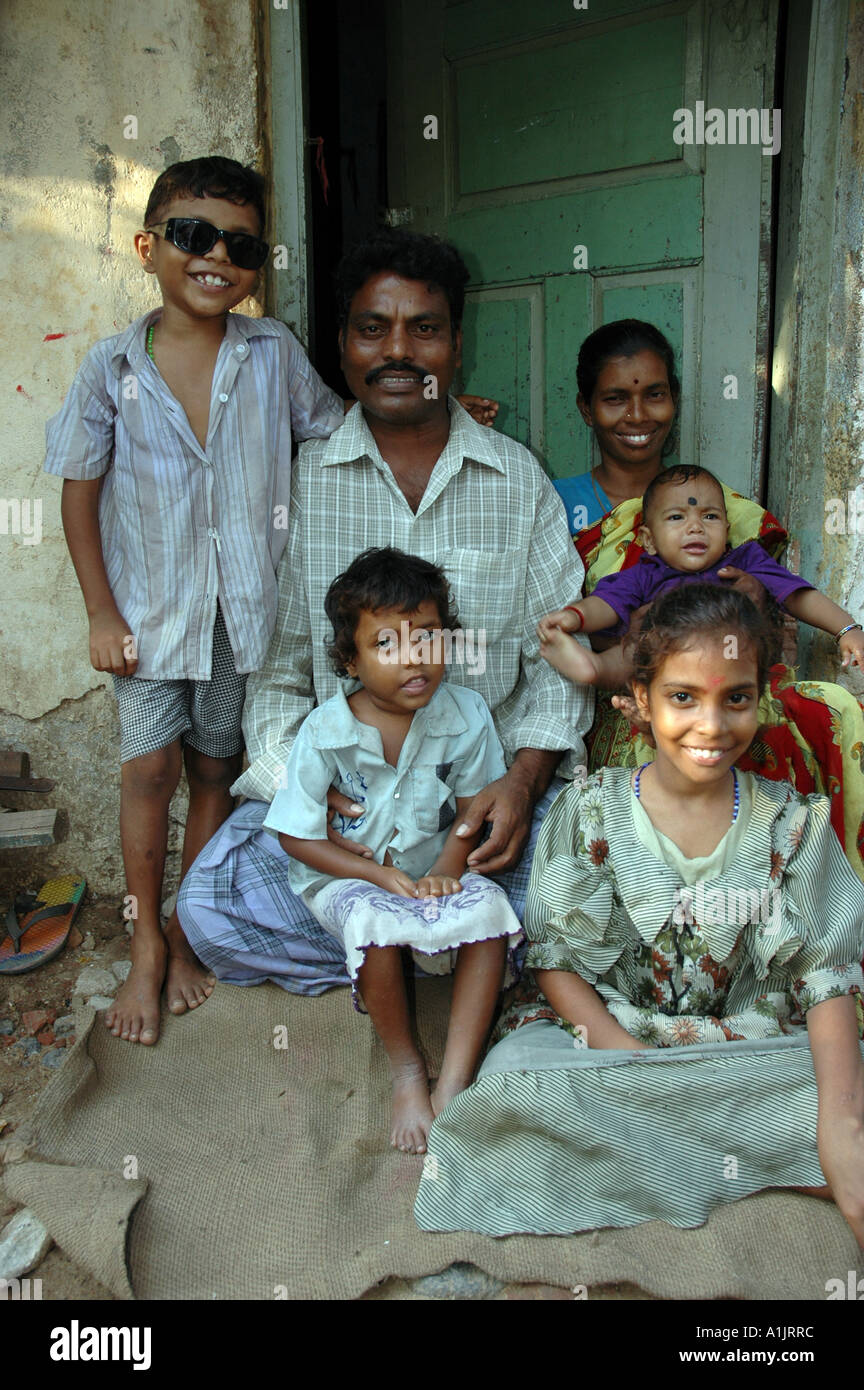 A family in India outside their modest home Stock Photo - Alamy