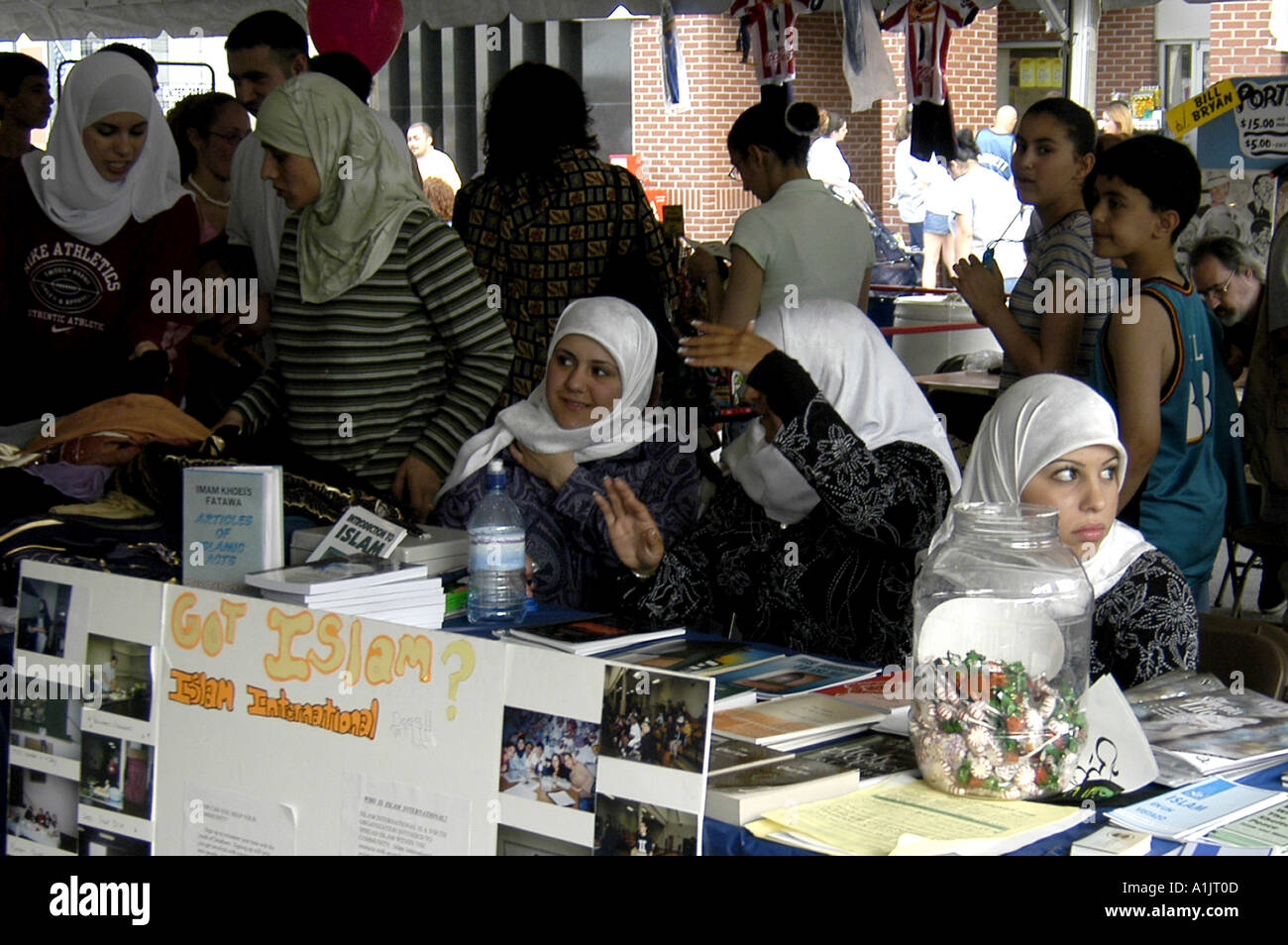 Two Young Arab Women In Hijabs Work the Islam International Booth Arab ...