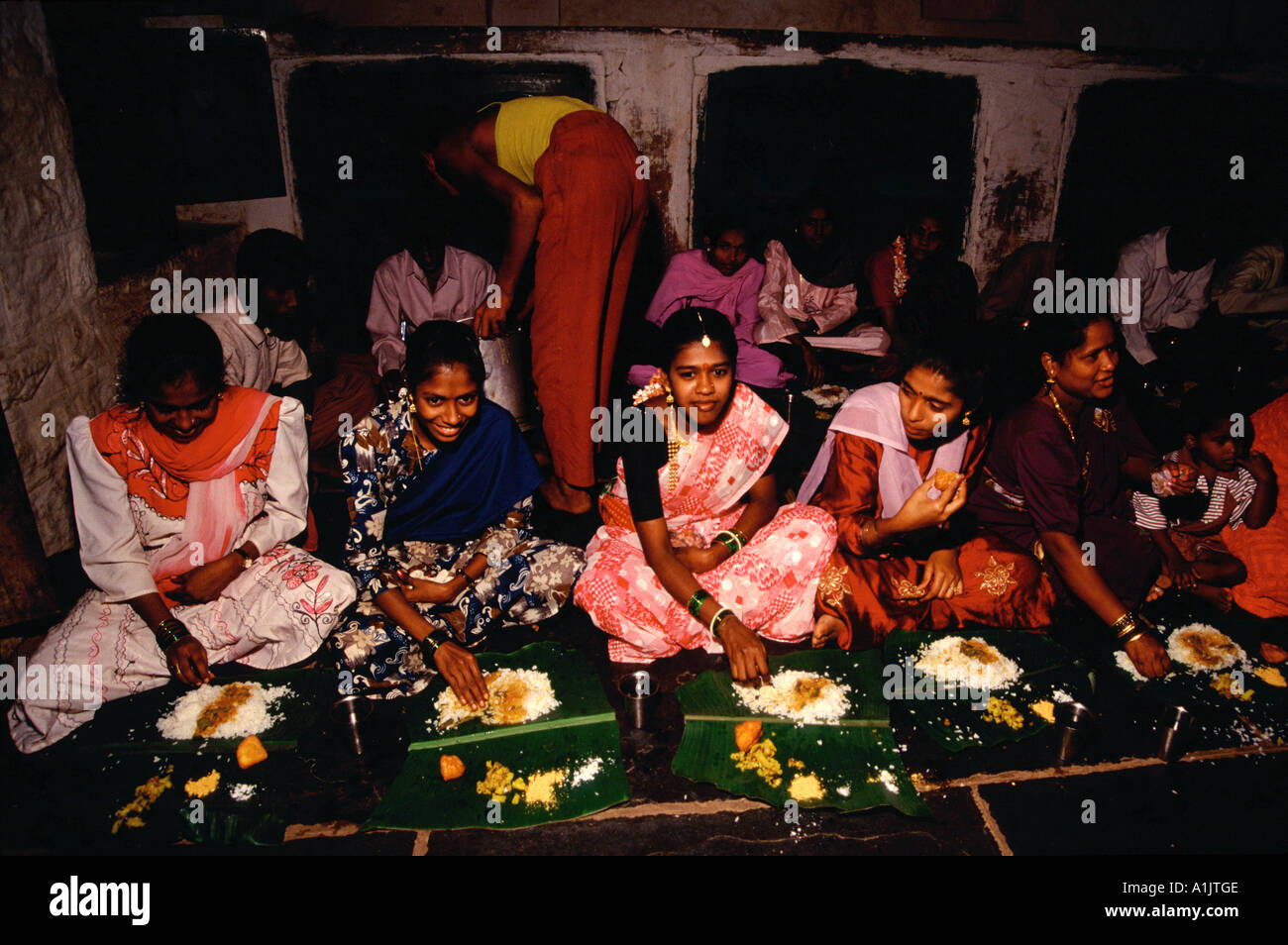Guests eating traditional food at a Hindi wedding in the ancient ...