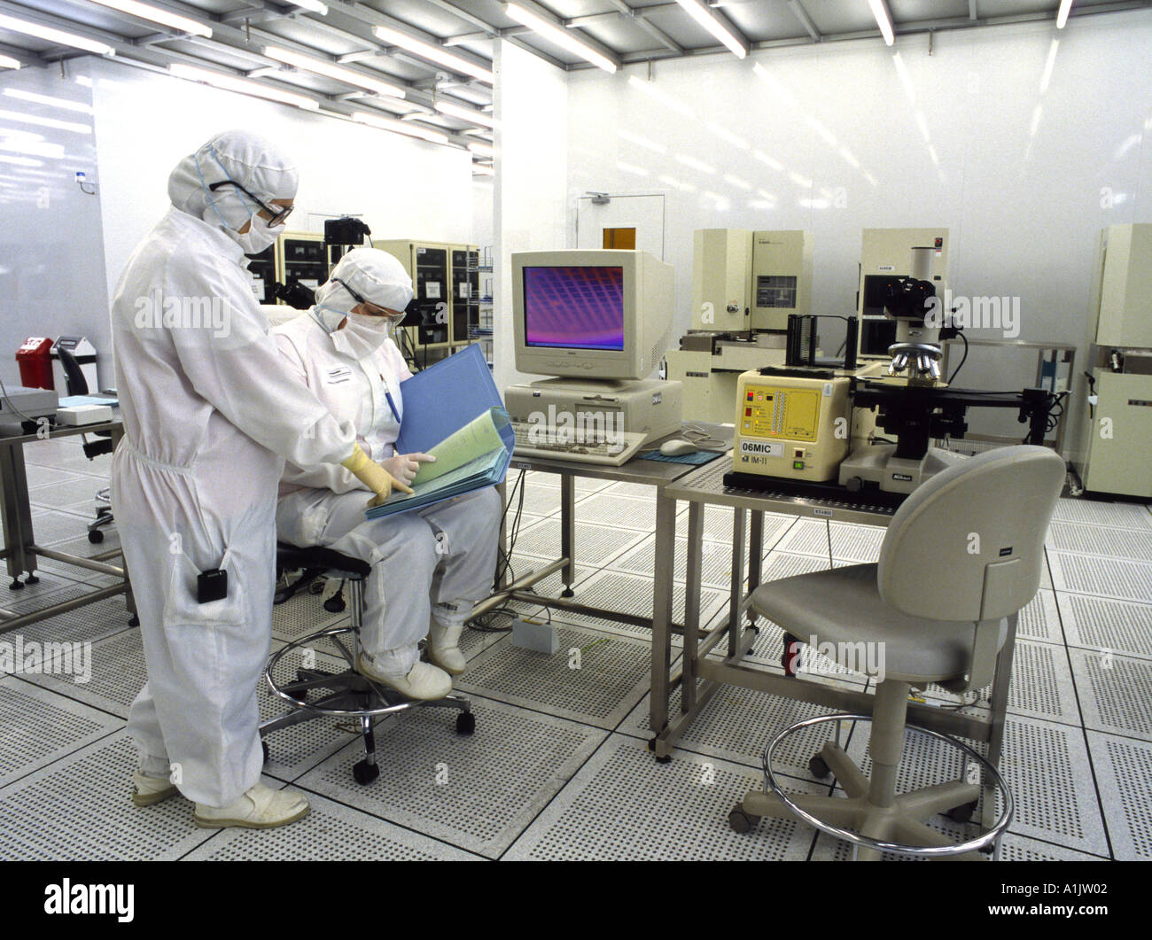 Checking silicon micro chips in a hi tech factory Stock Photo - Alamy