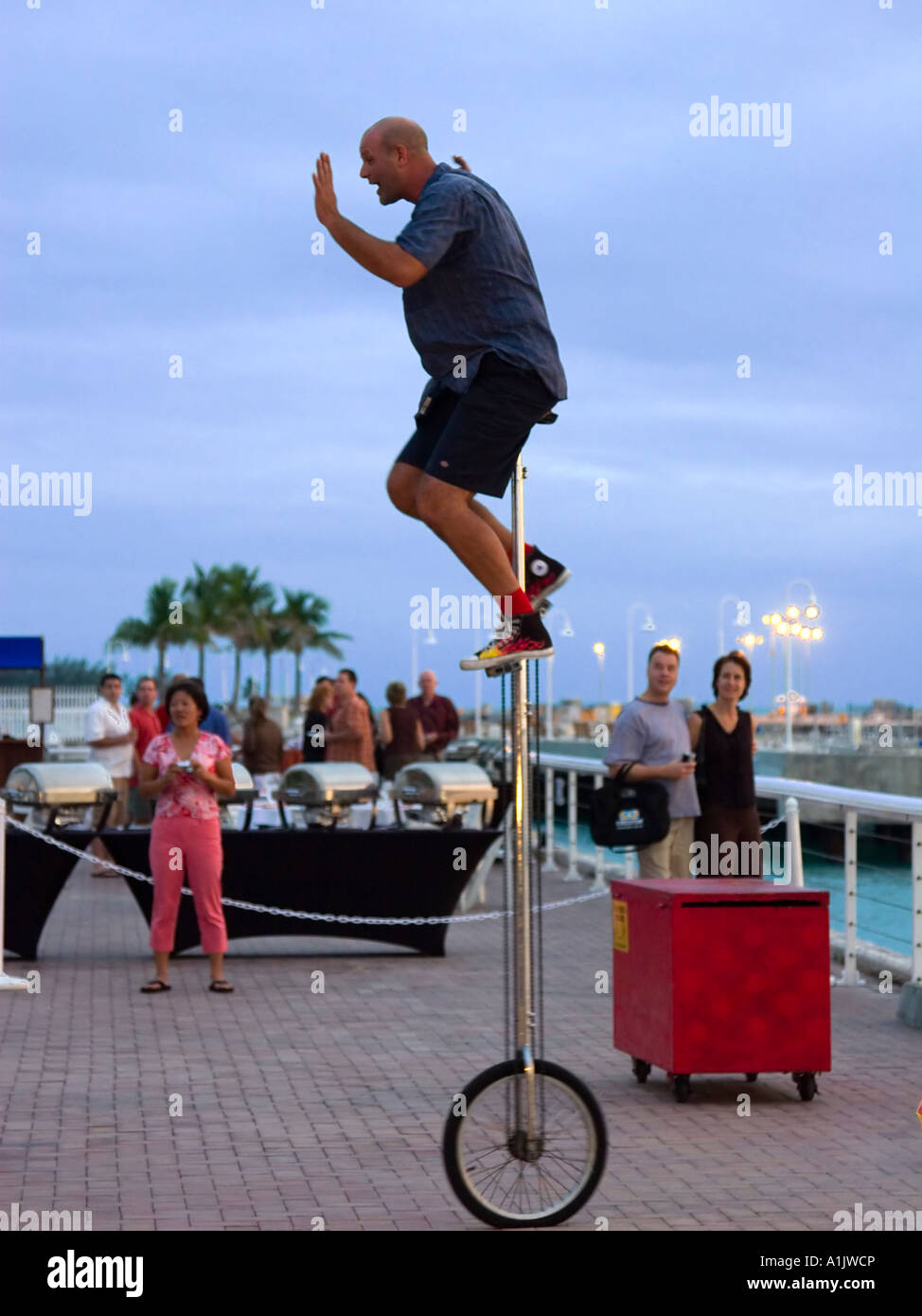 Unicyclist rides for the crowd Stock Photo - Alamy