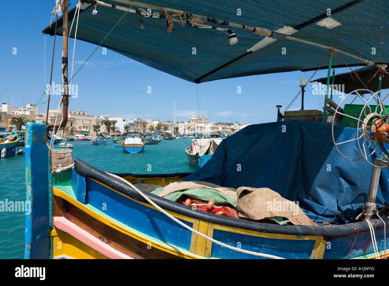 Typical local fishing boat in the harbour at Marsaxlokk, Malta Stock ...