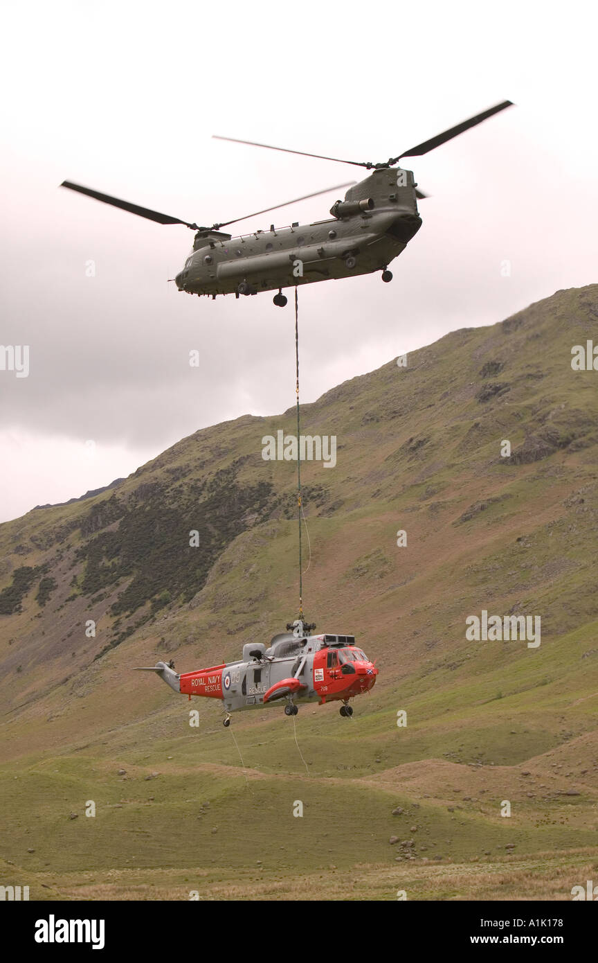 A Chinook Helicopter air lifts a Navy Sea King helicopter out of the ...