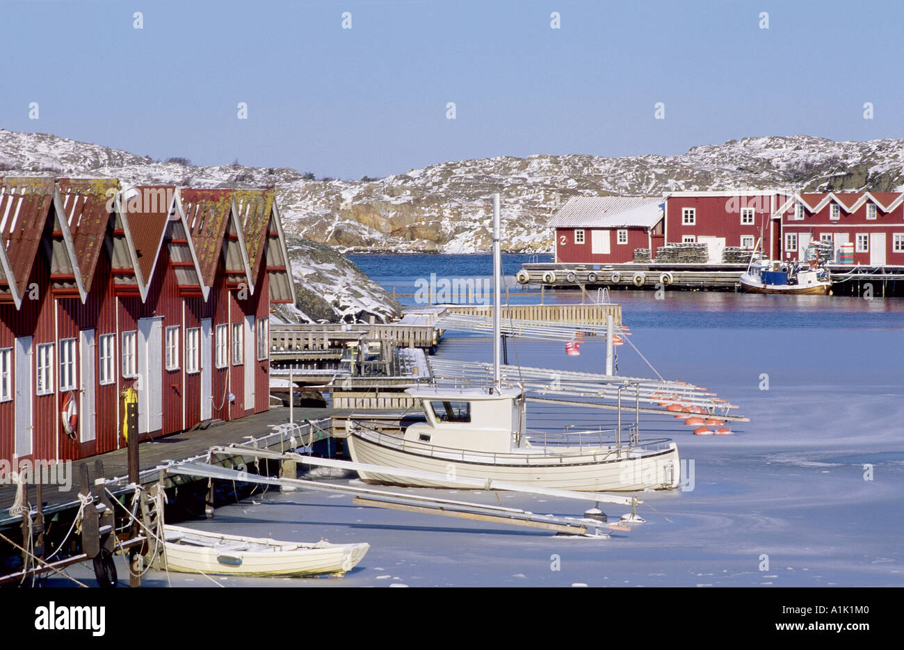 Winter harbour with red fishing cabins Stock Photo - Alamy