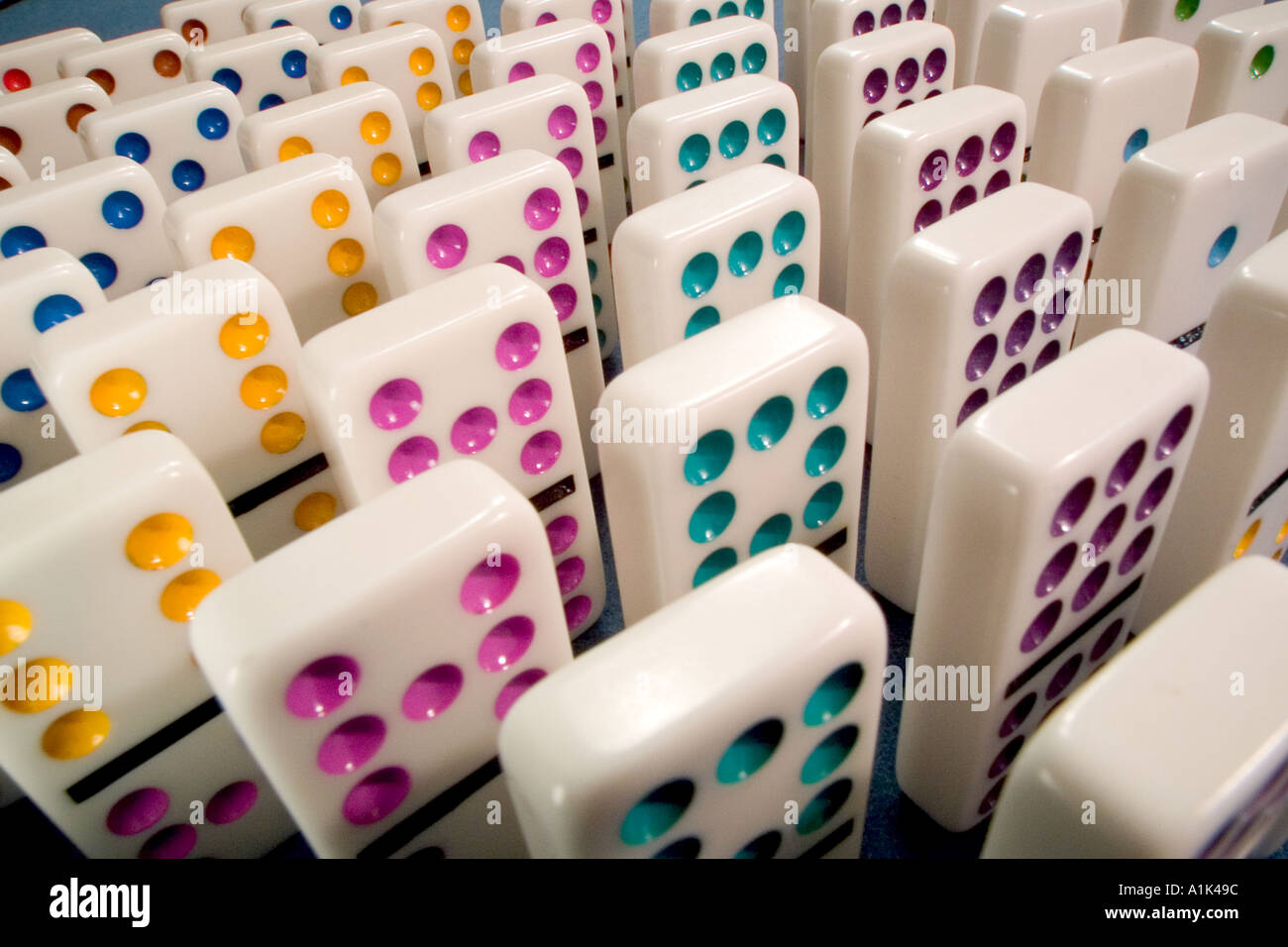 Uniform rows of colored dominoes form line pattern Stock Photo - Alamy