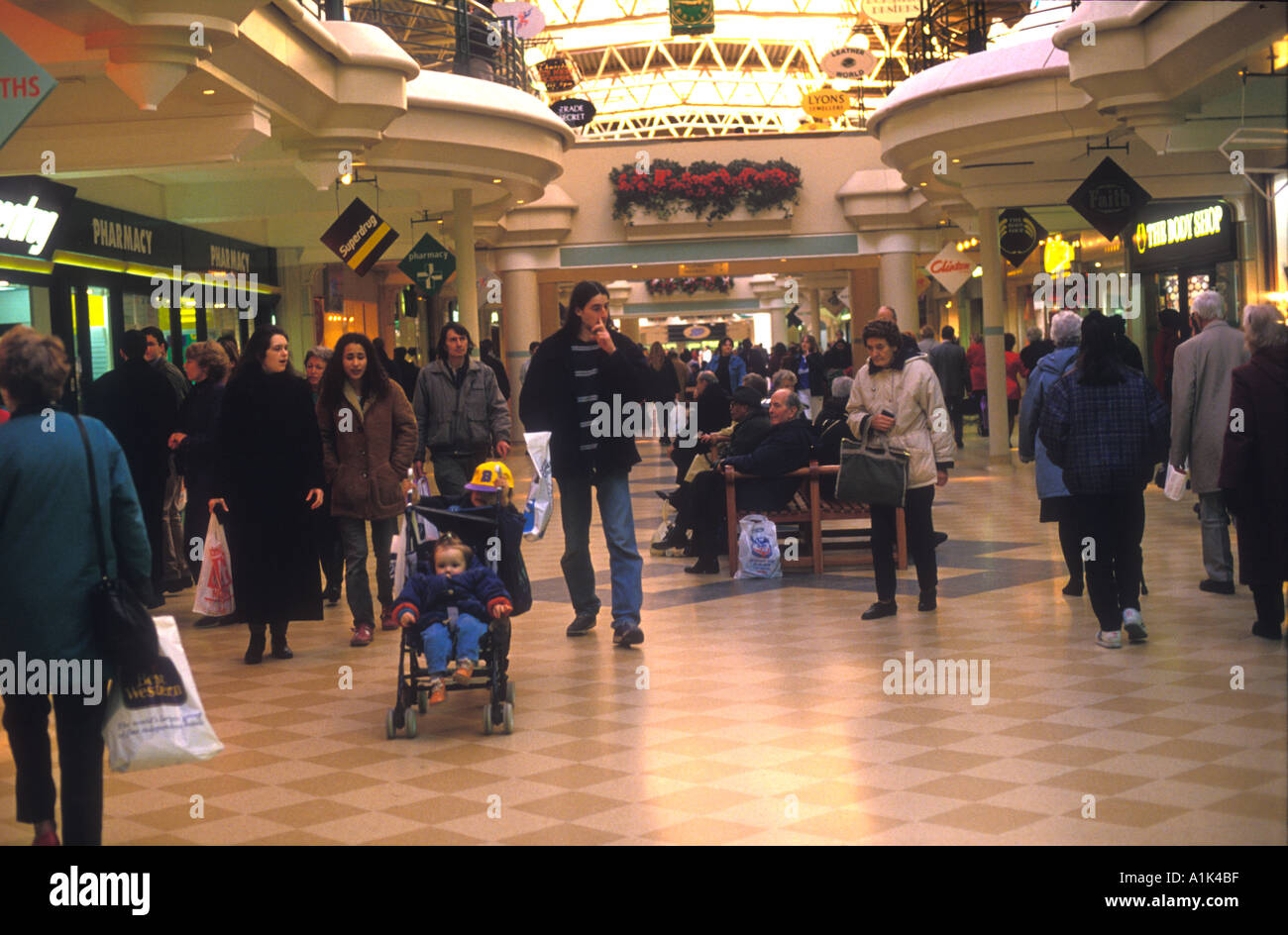People in crowded shopping centre in London suburb Stock Photo - Alamy
