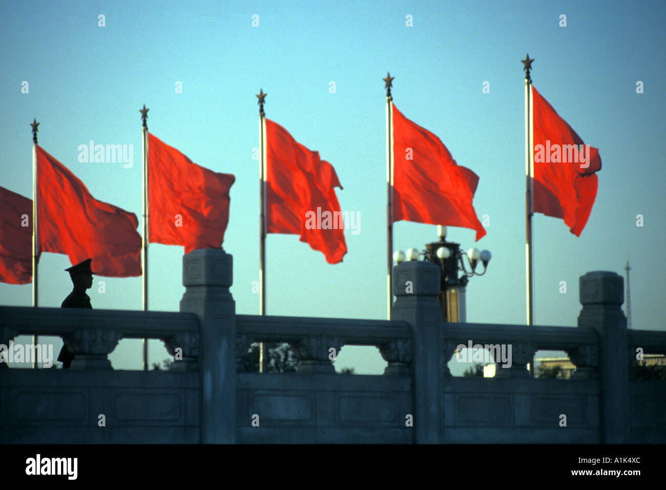 Chinese PLA soldier on guard near flags in front of Tiananmen Gate ...