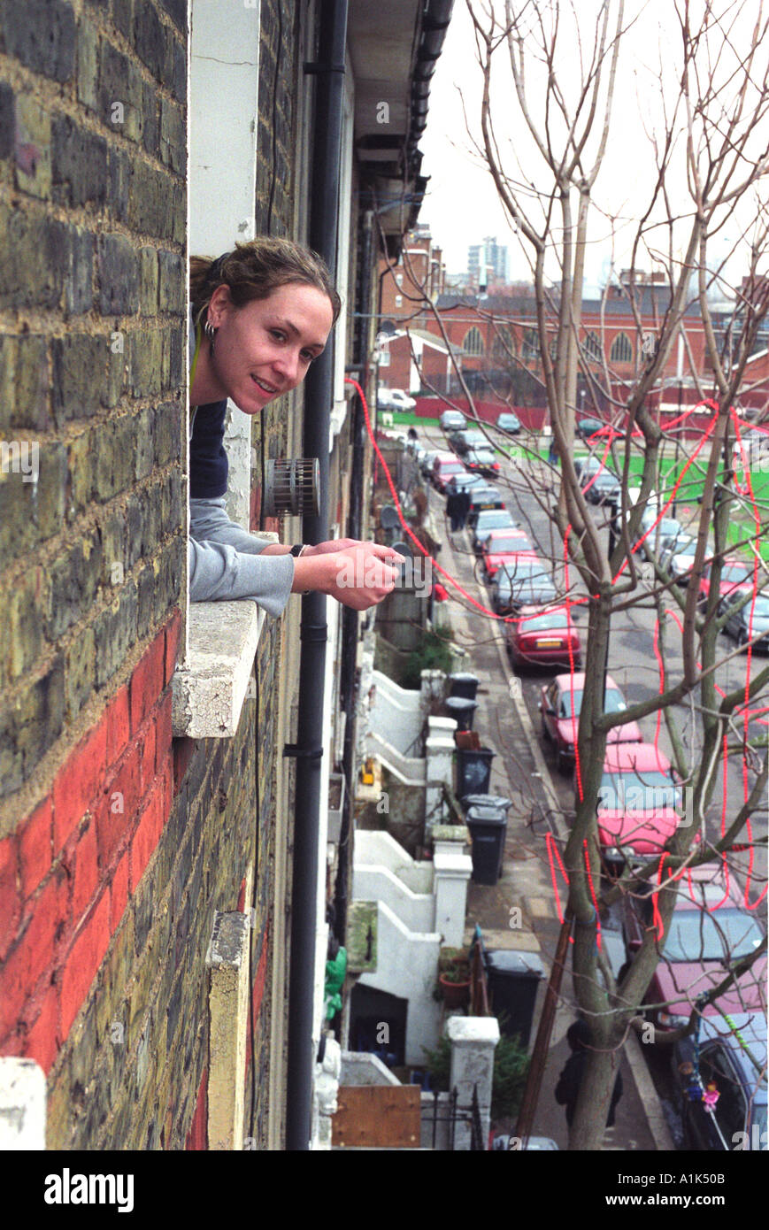 Woman looking out the window at Saint Agnes Place squat at the Oval ...