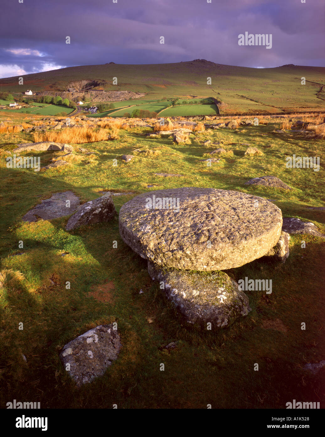 Hut circle remains and a huge circular granite slab at Merrivale ...