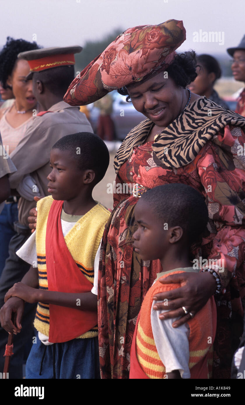 Herero woman wearing traditional dress with her children at the Ma ...