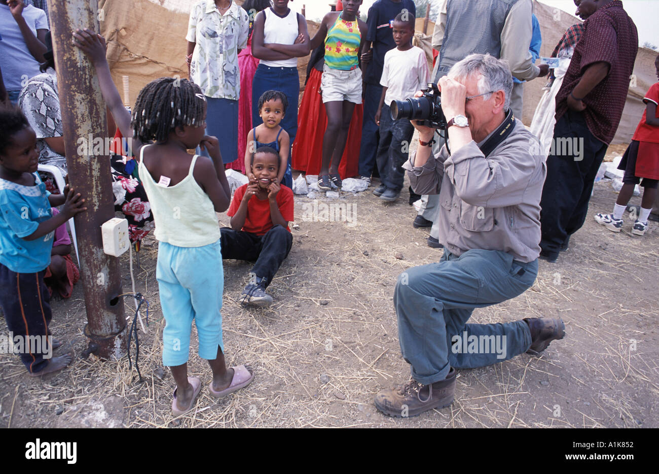 Herero girl being photographed by a professional photographer with ...