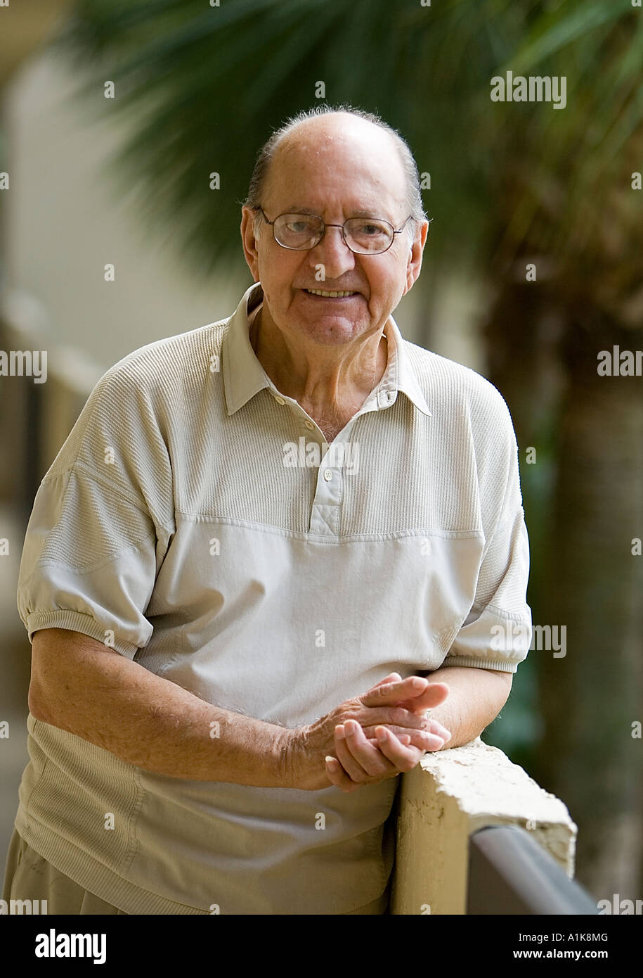 Elderly man leaning on fence hi-res stock photography and images - Alamy