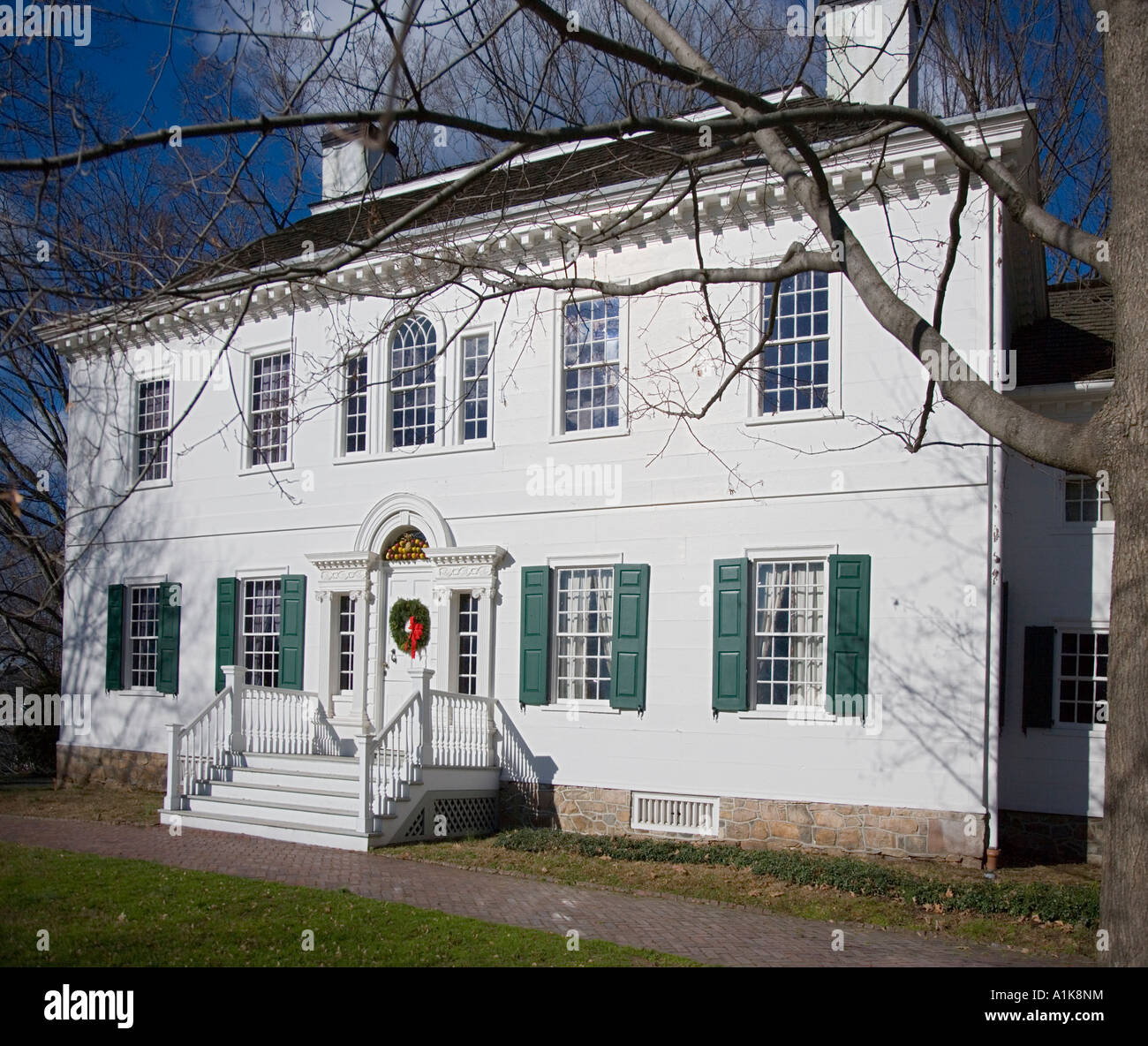 Classic colonial house with Christmas wreath Stock Photo - Alamy