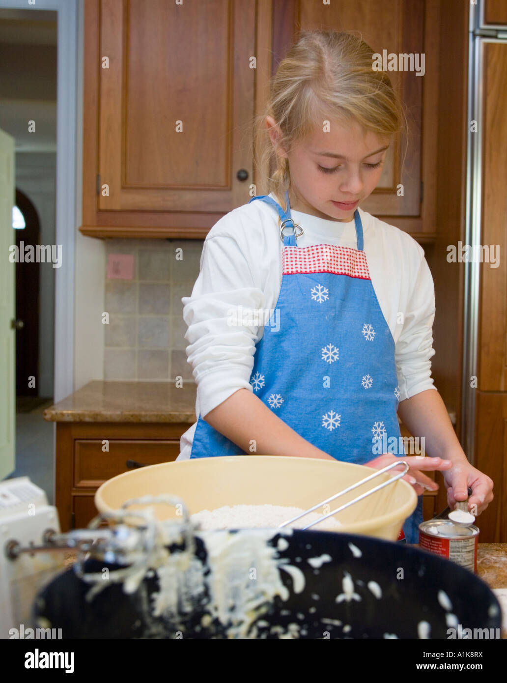 Child adding ingredients to a batter Stock Photo - Alamy