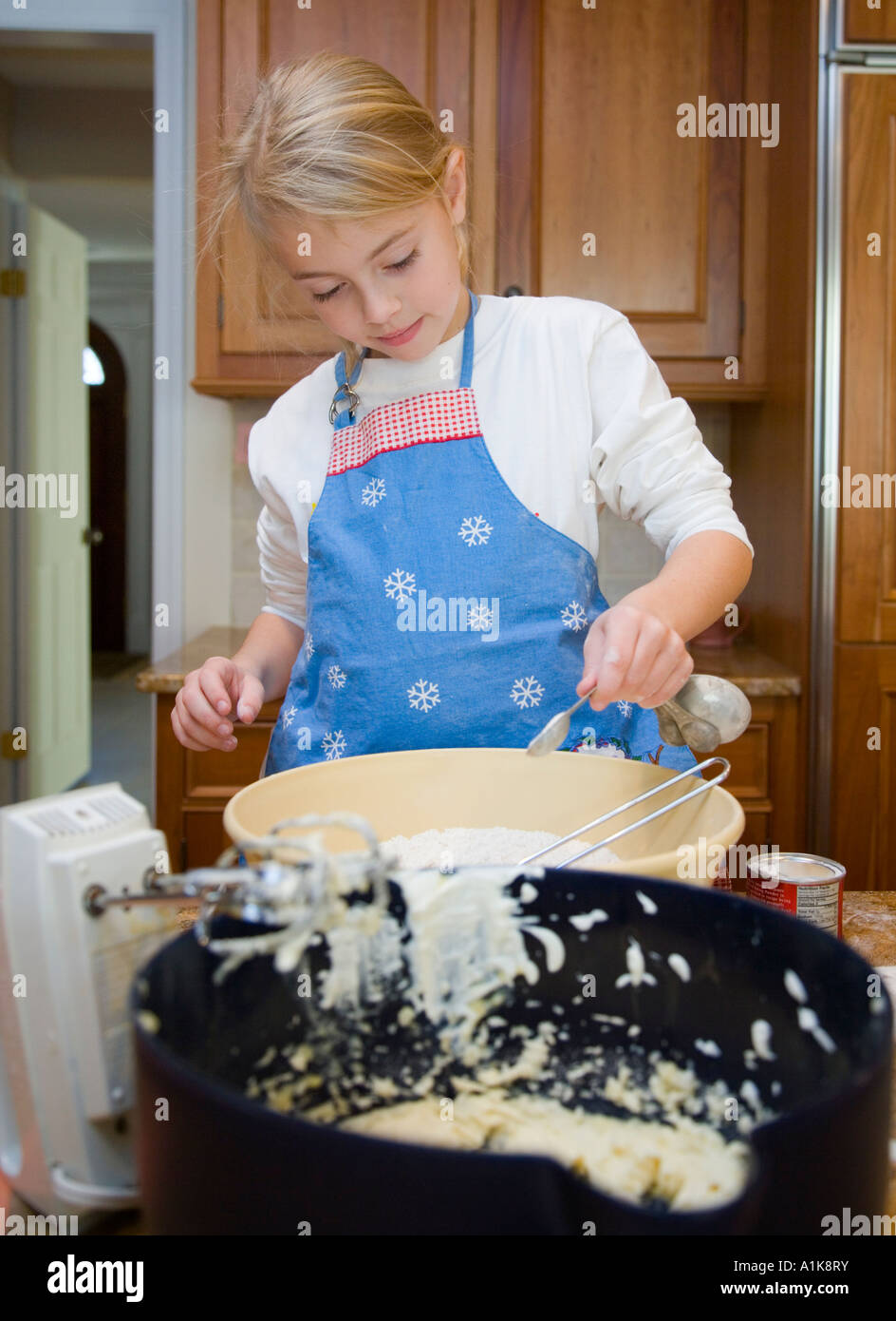 Child adding ingredients to a mixing bowl Stock Photo - Alamy