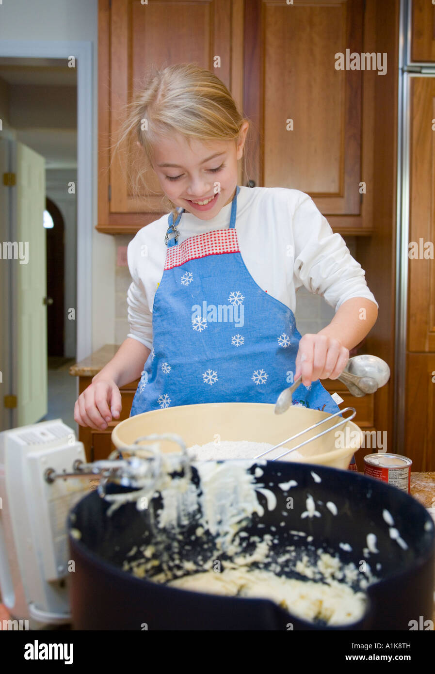Child adding ingredients to a mixing bowl Stock Photo - Alamy