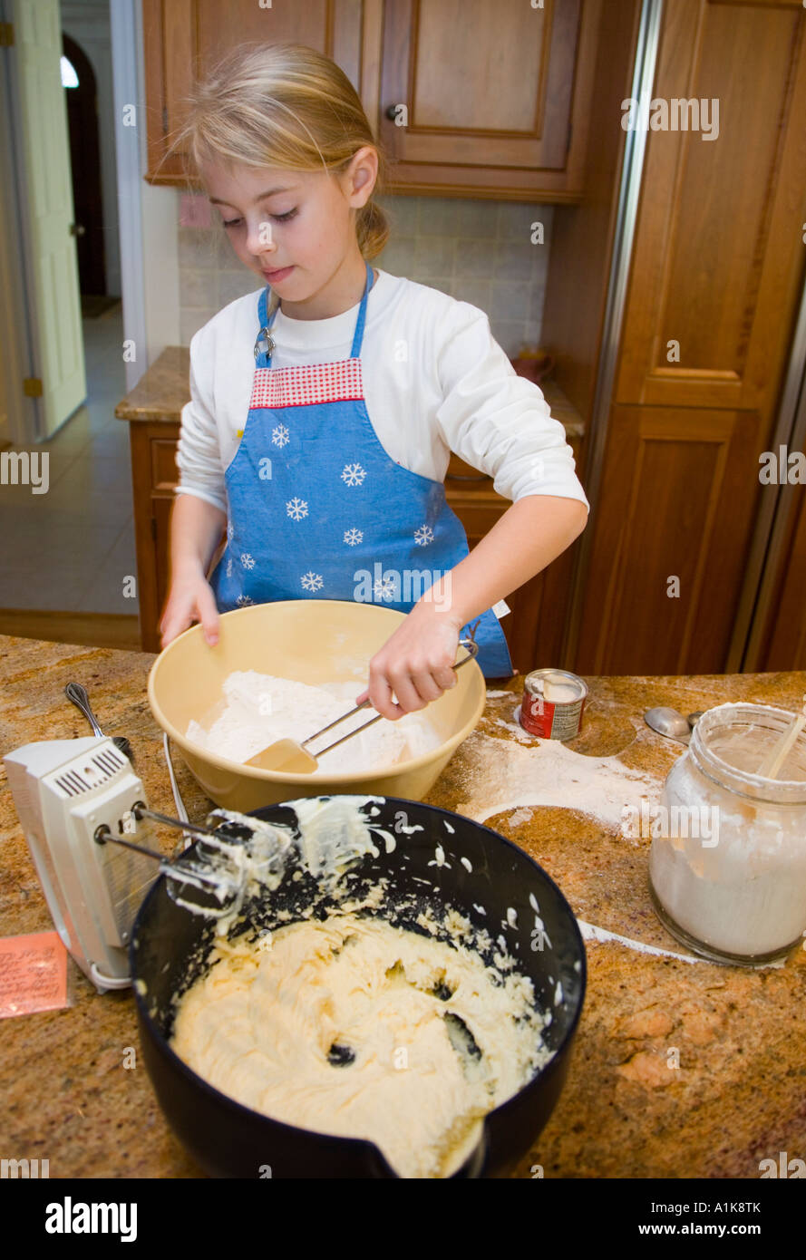 Young girl mixing a batter Stock Photo - Alamy