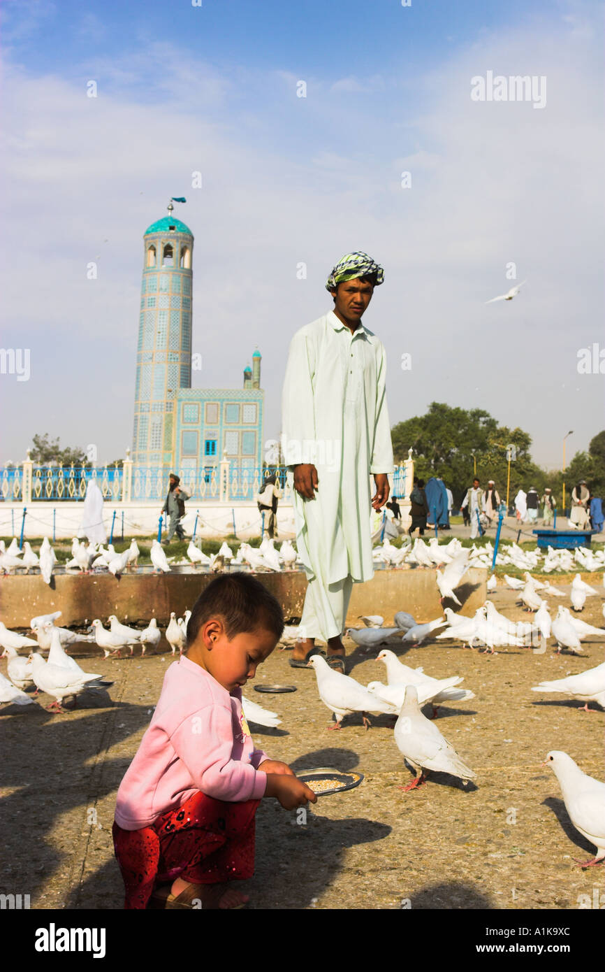 AFGHANISTAN Mazar I Sharif Girl feeding famous white pigeons at Shrine ...