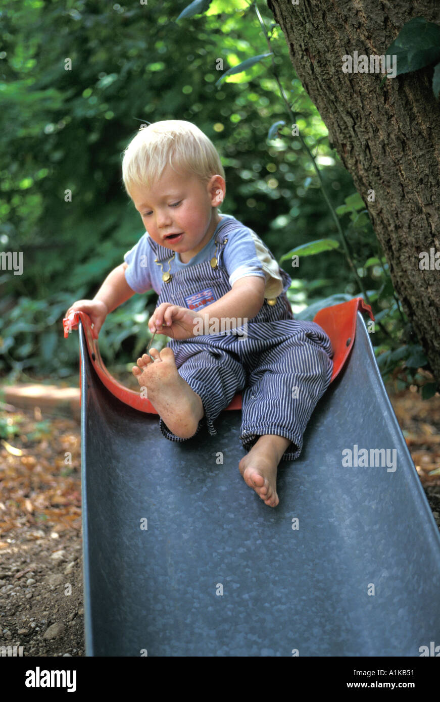 Two year old boy on slide MR Stock Photo - Alamy